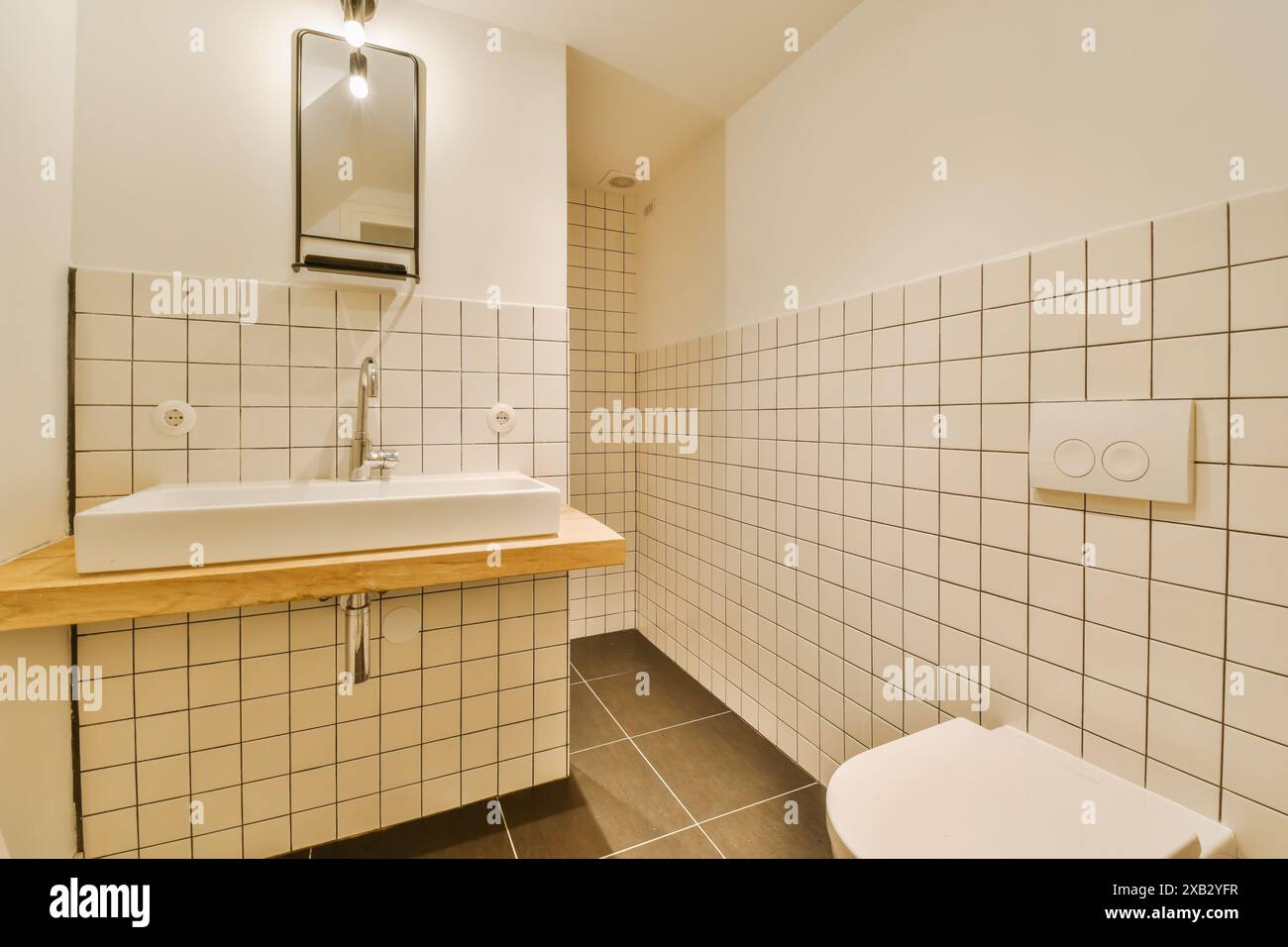 A modern bathroom featuring white tile walls with grid pattern, wooden ...