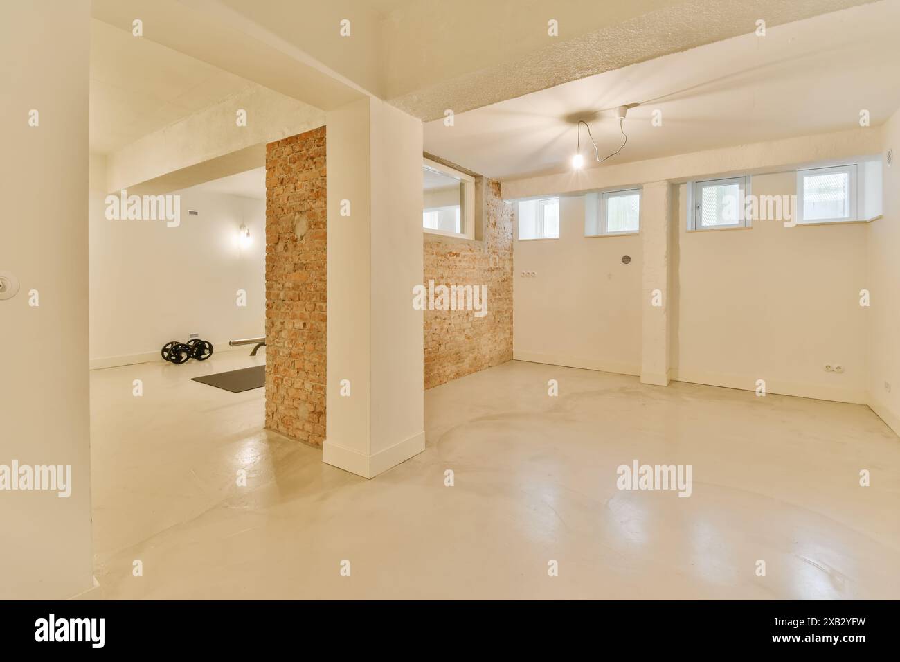 Empty basement interior showcasing a large room with polished concrete ...