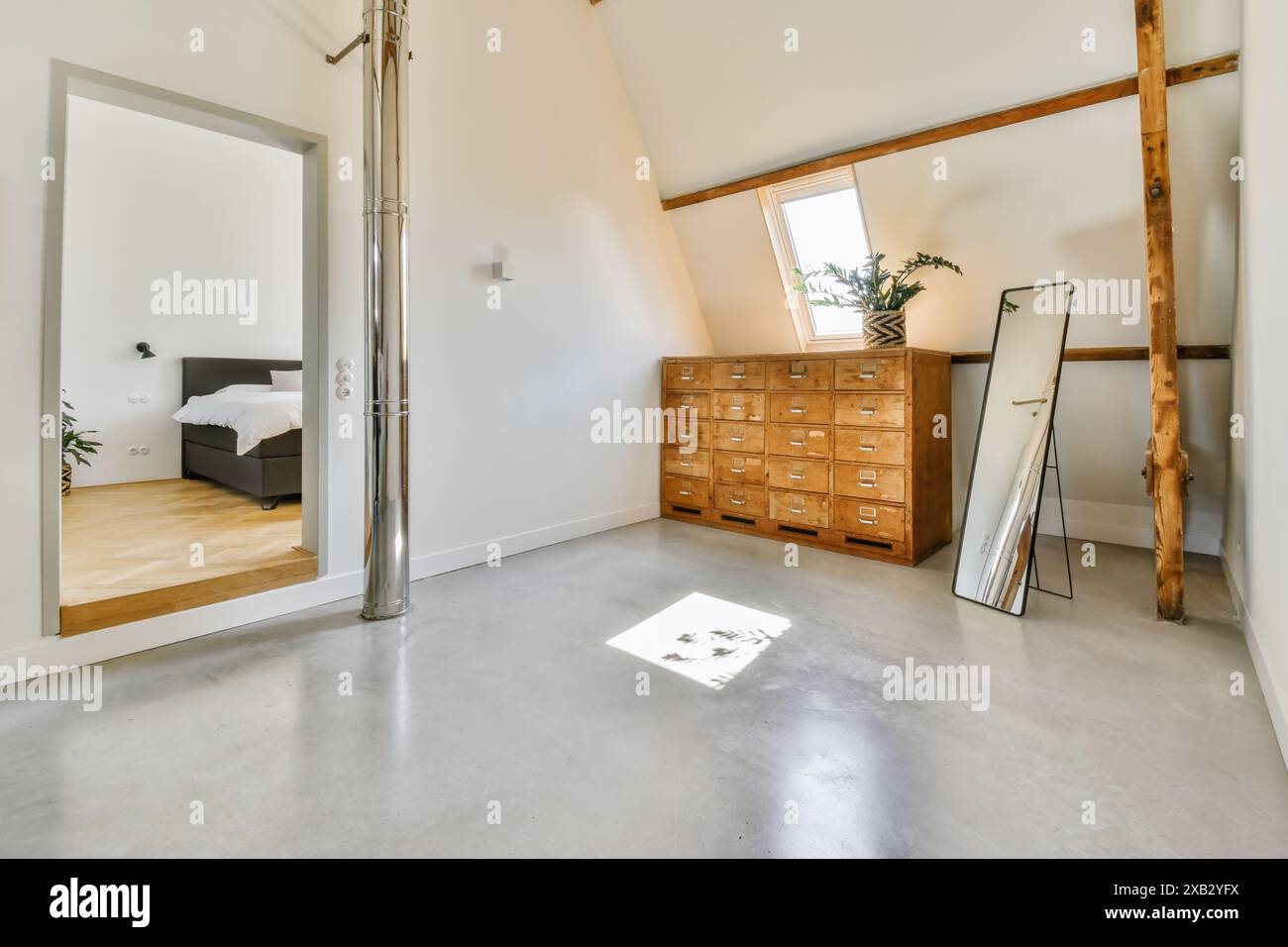 A warmly lit cozy bedroom featuring a wooden drawer cabinet, polished ...