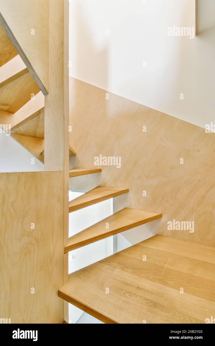 A close-up view of a contemporary wooden staircase with a light birch ...