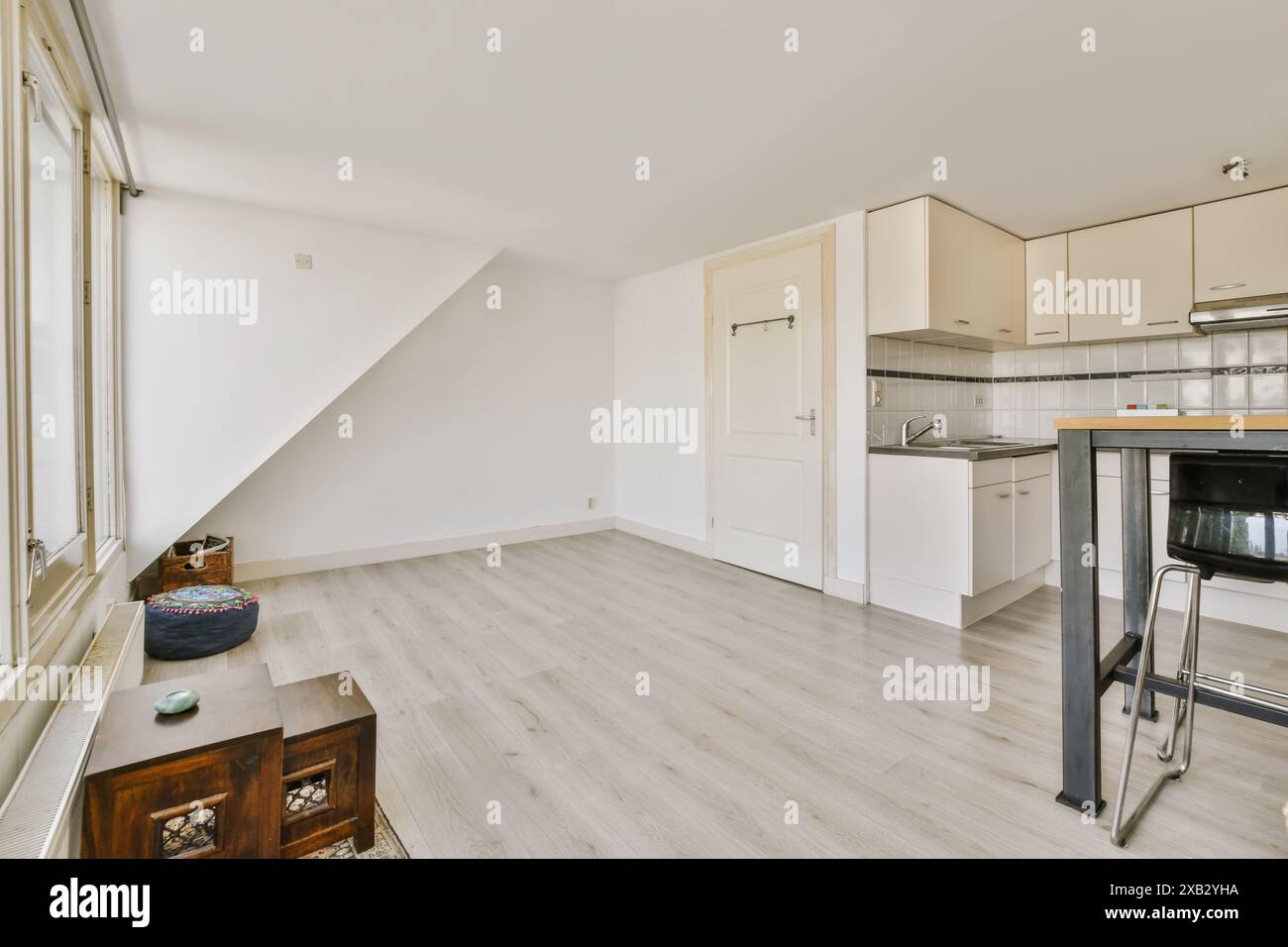 Bright and airy studio interior with white walls, modern kitchen, and ...