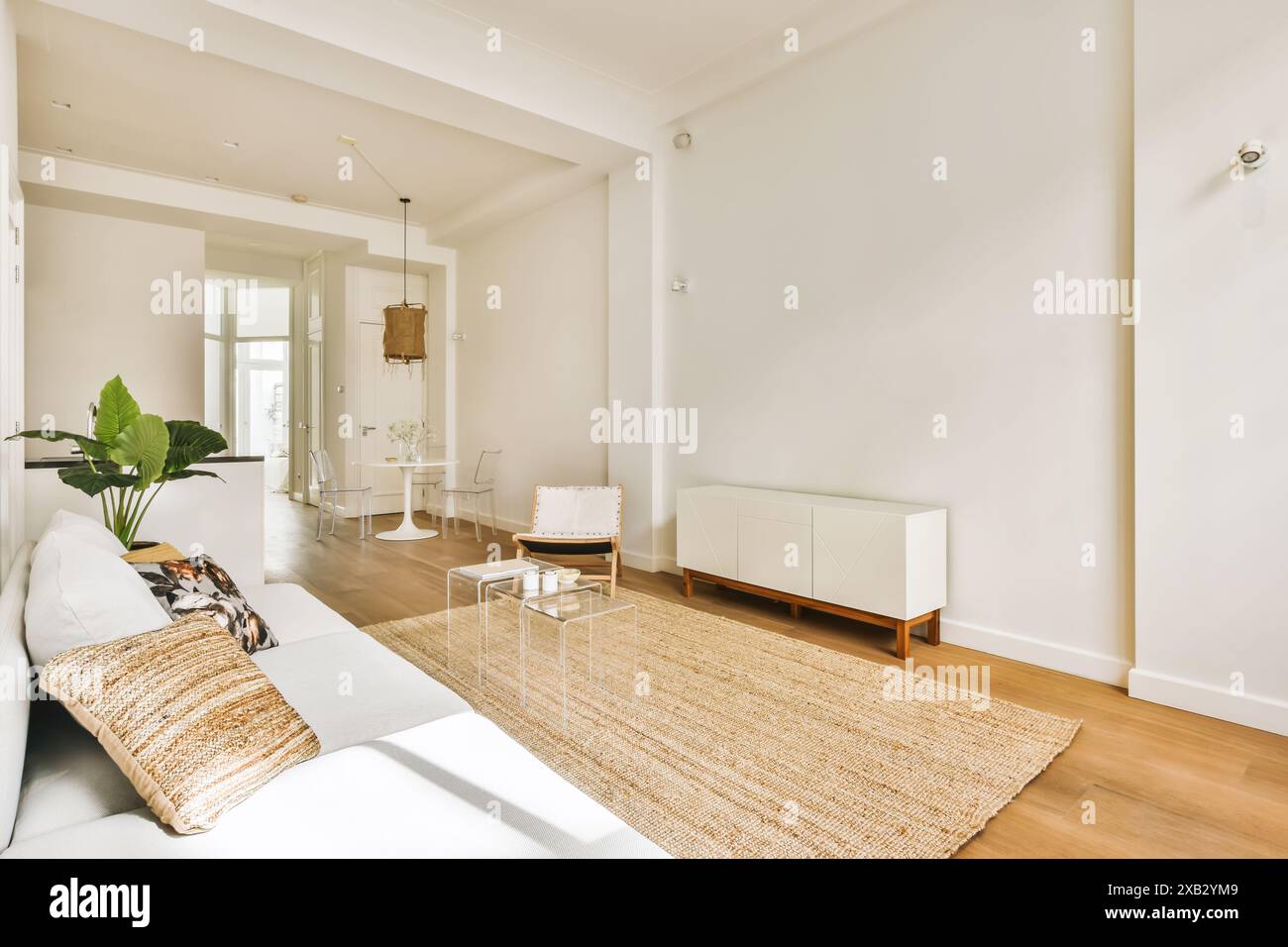 A spacious and luminous living room features contemporary furniture ...