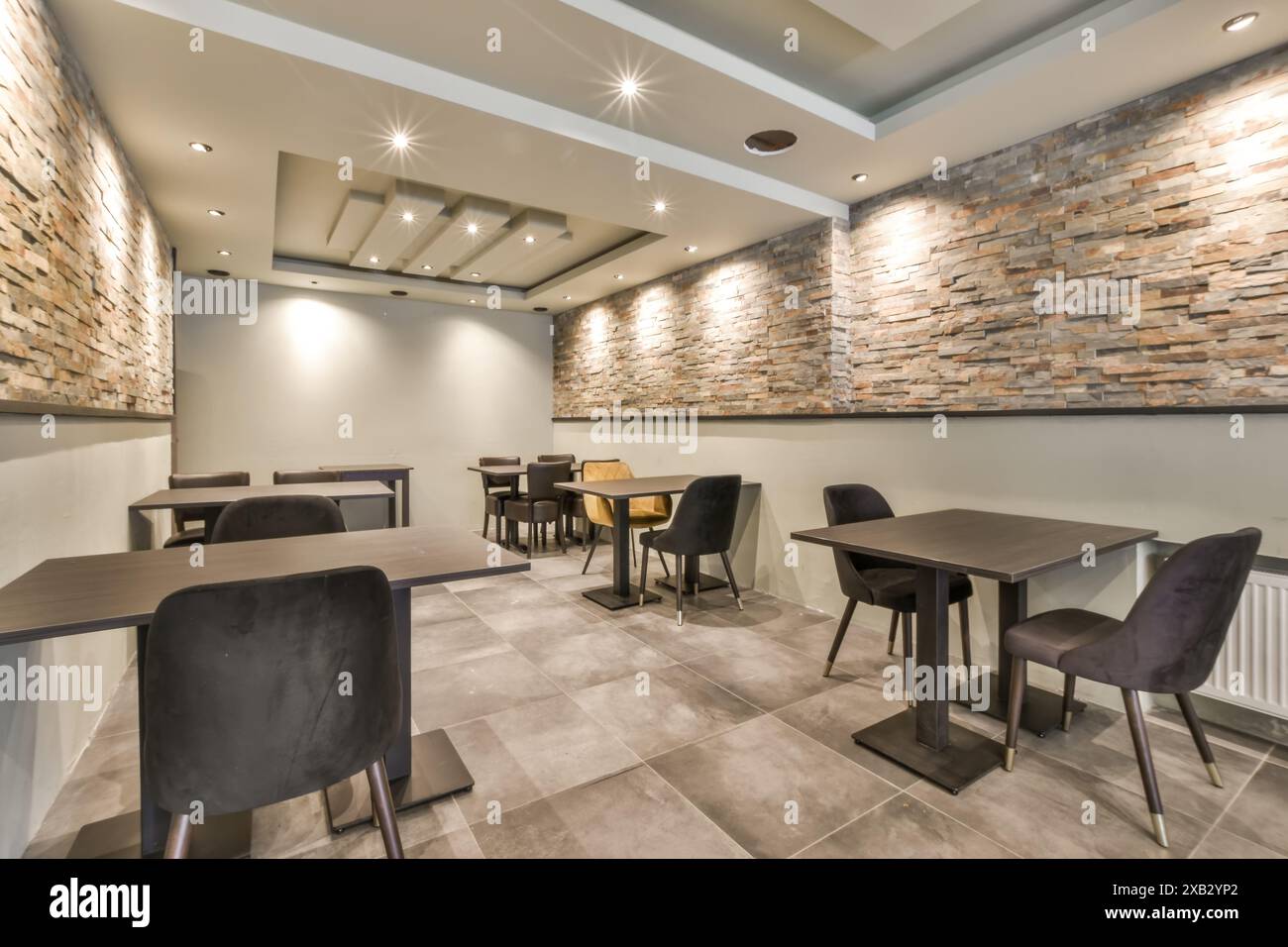This image displays a chic cafe interior with elegant stone wall ...