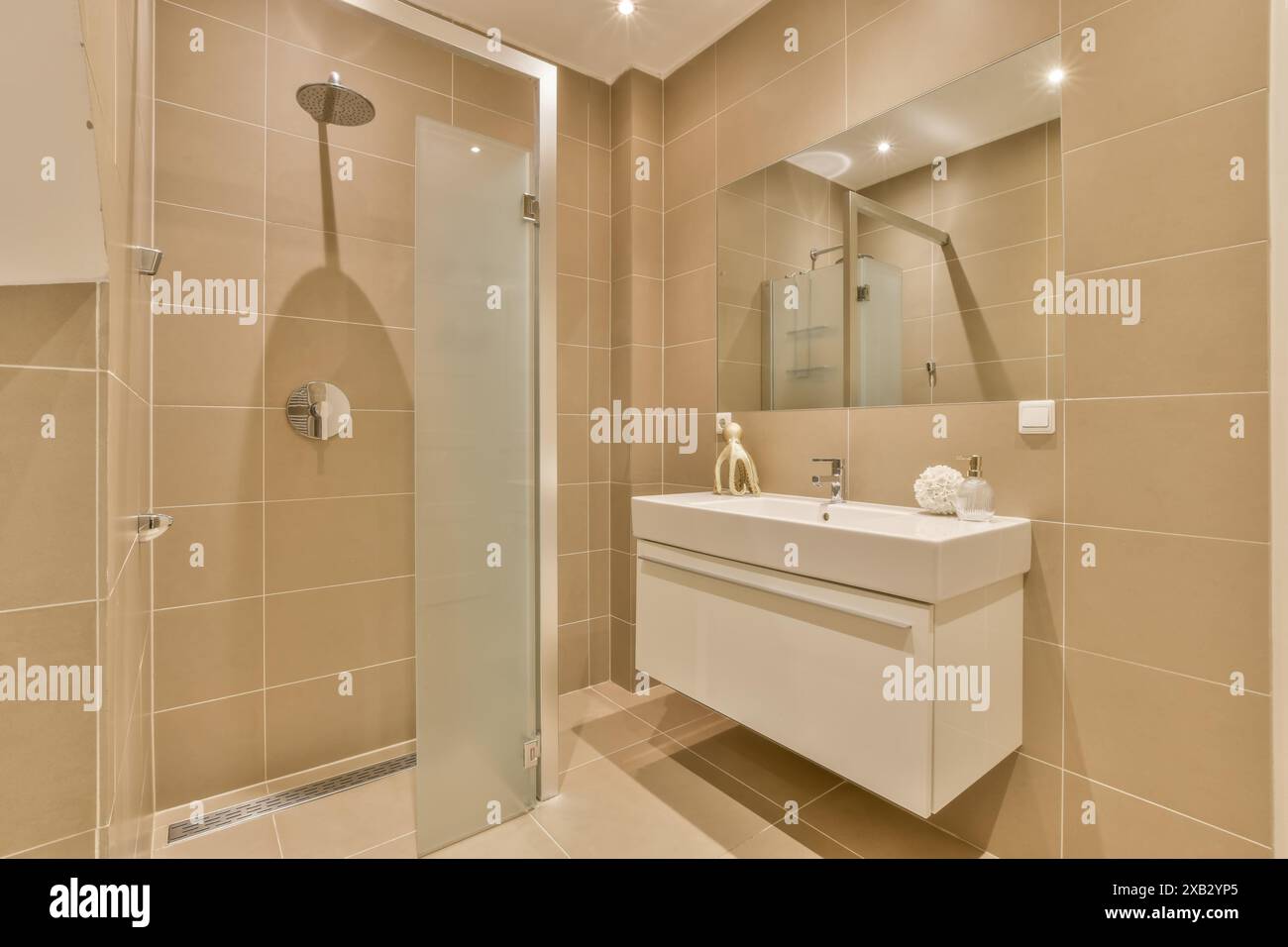 A contemporary bathroom with beige tiles, walk-in shower, and white ...