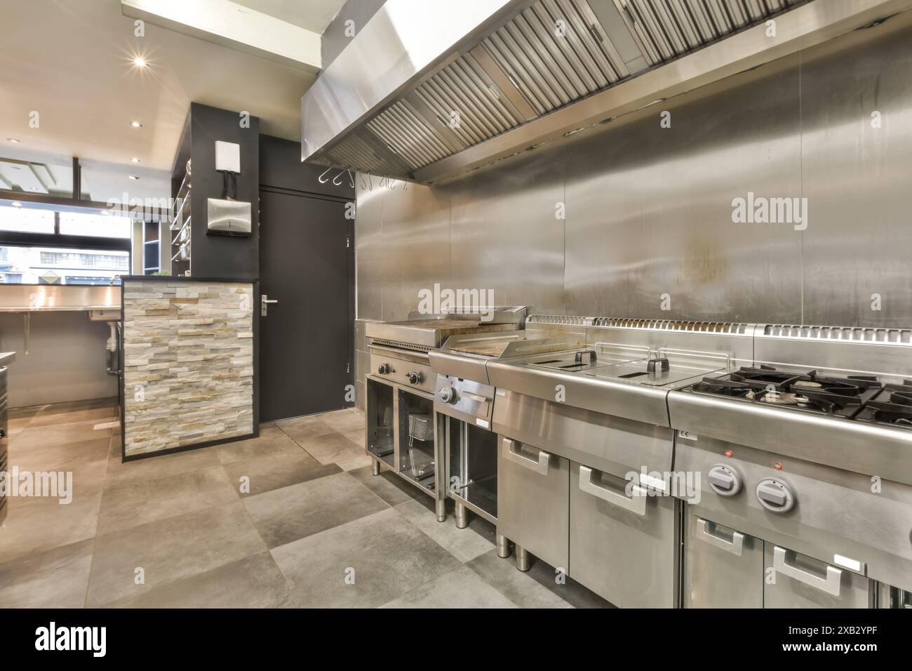 Spacious, well-equipped commercial kitchen featuring stainless steel ...