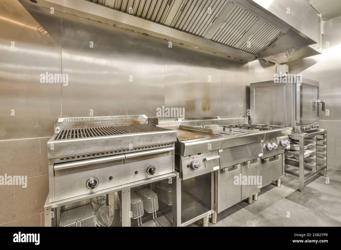 A spacious commercial kitchen with modern stainless steel appliances ...