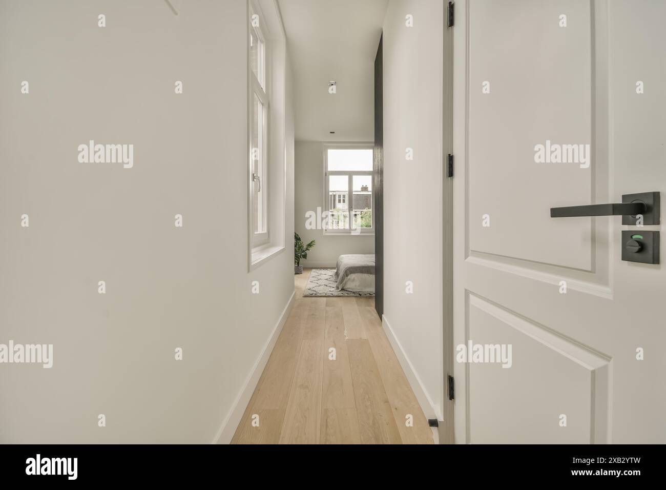 A well-lit hallway in a contemporary home, featuring sleek white walls ...