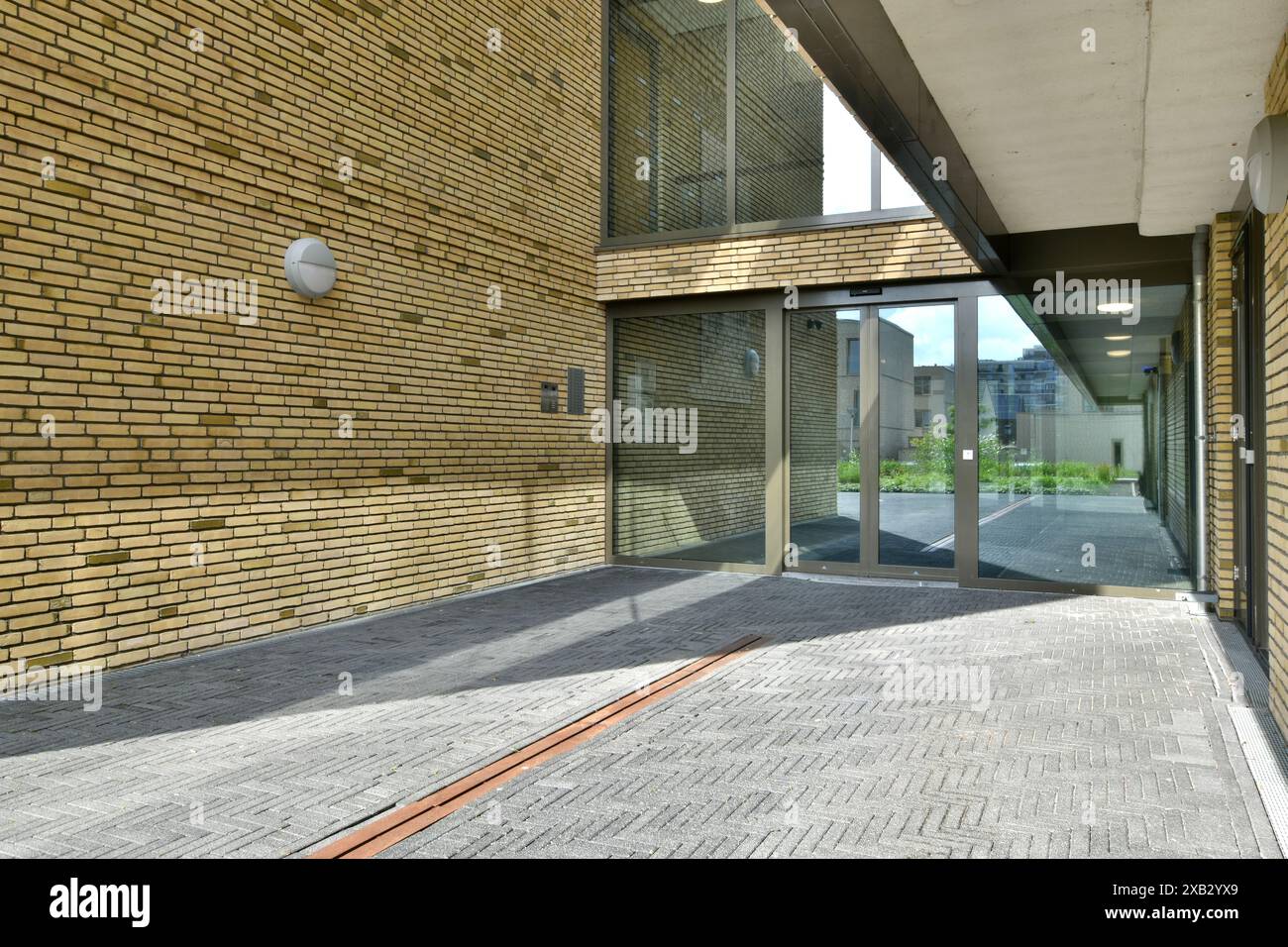 A contemporary entrance way of a modern building with transparent glass ...
