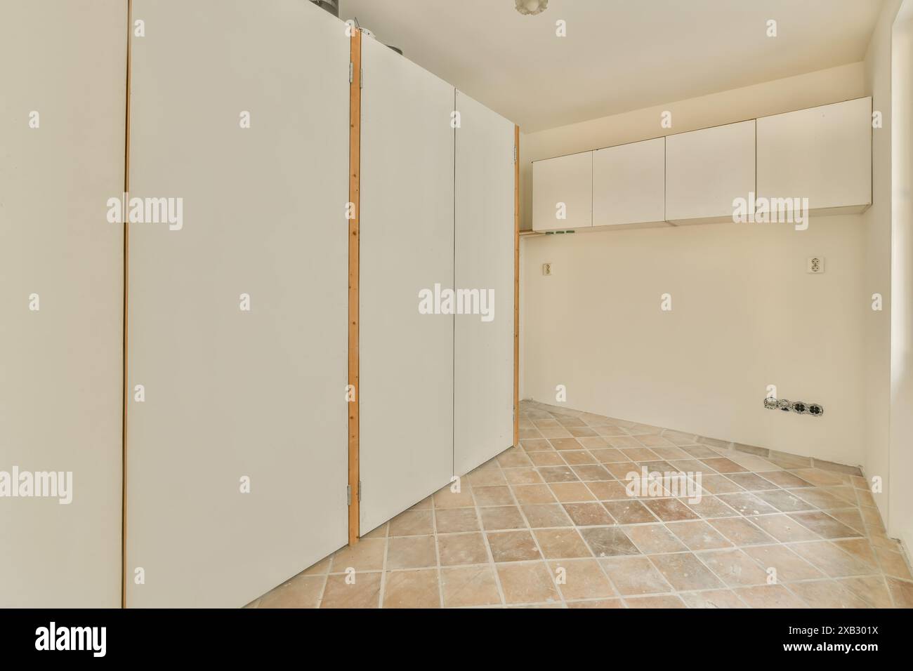 A vacant interior space featuring ceramic floor tiles and overhead ...