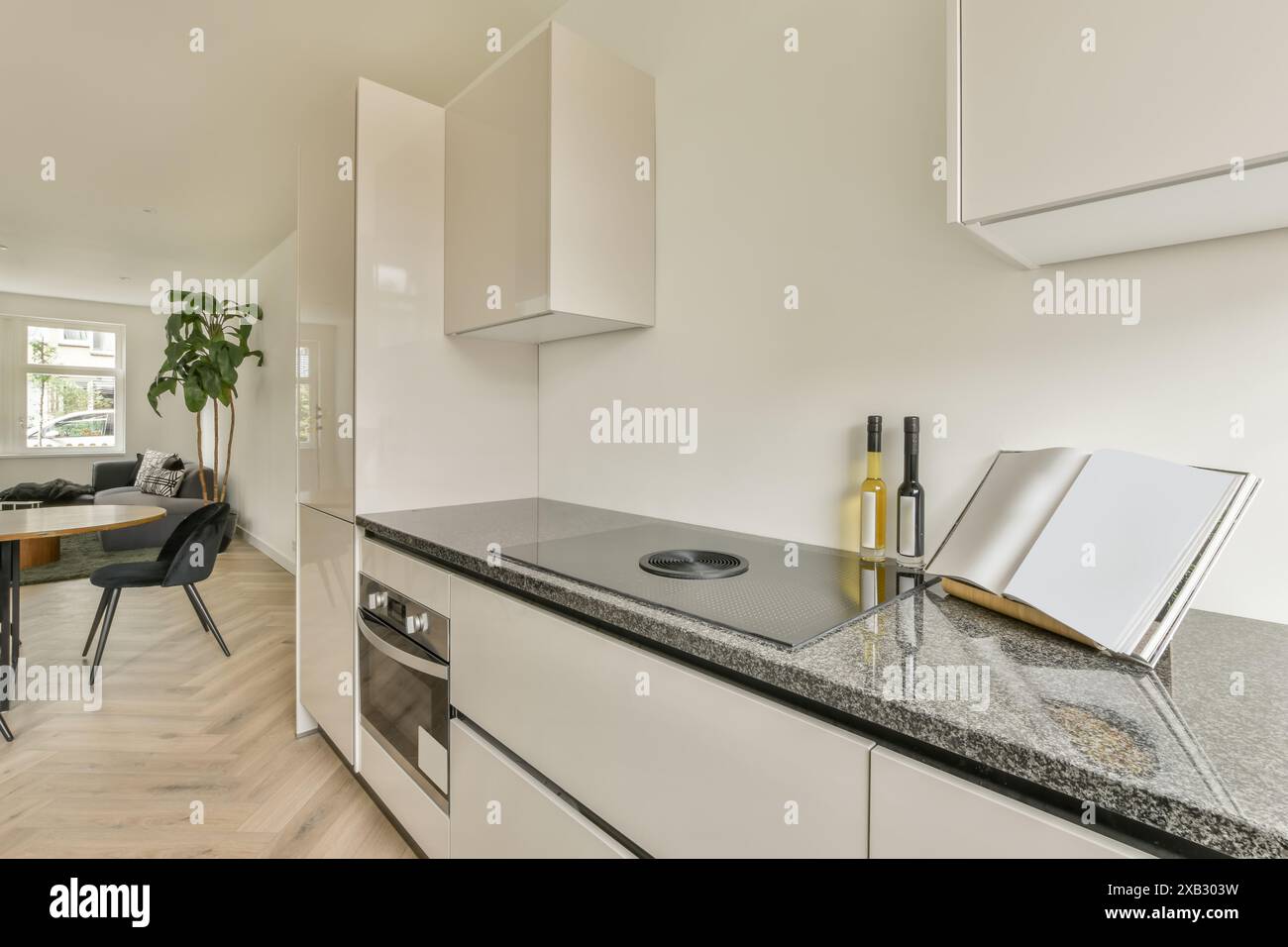 An elegantly designed modern kitchen featuring reflective white ...