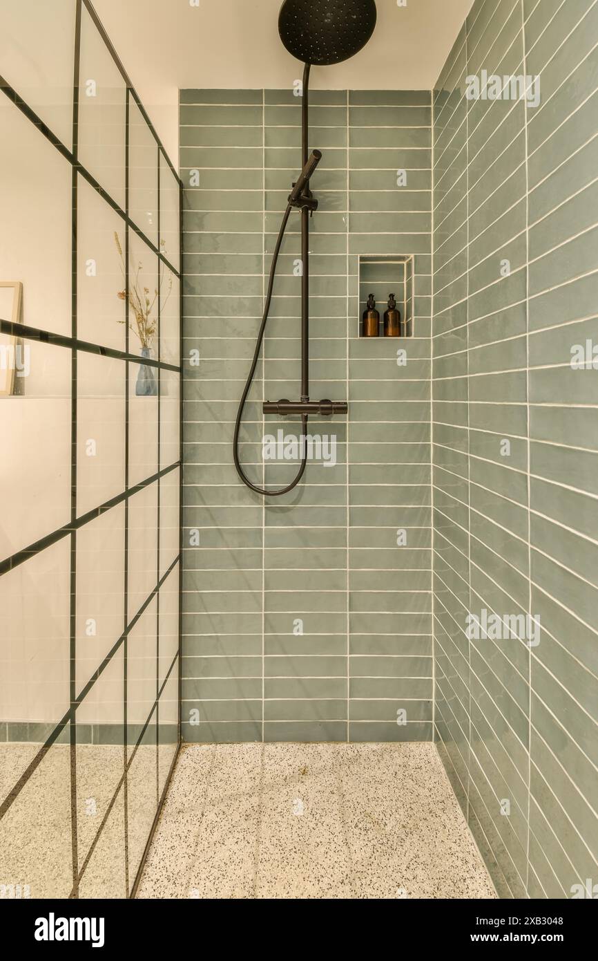 A contemporary bathroom featuring a walk-in shower with sea-green tiles ...