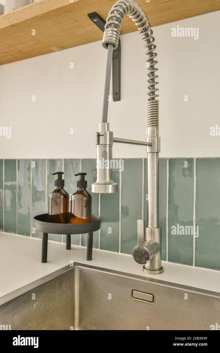 Close-up view of a modern kitchen sink with a stainless steel faucet ...