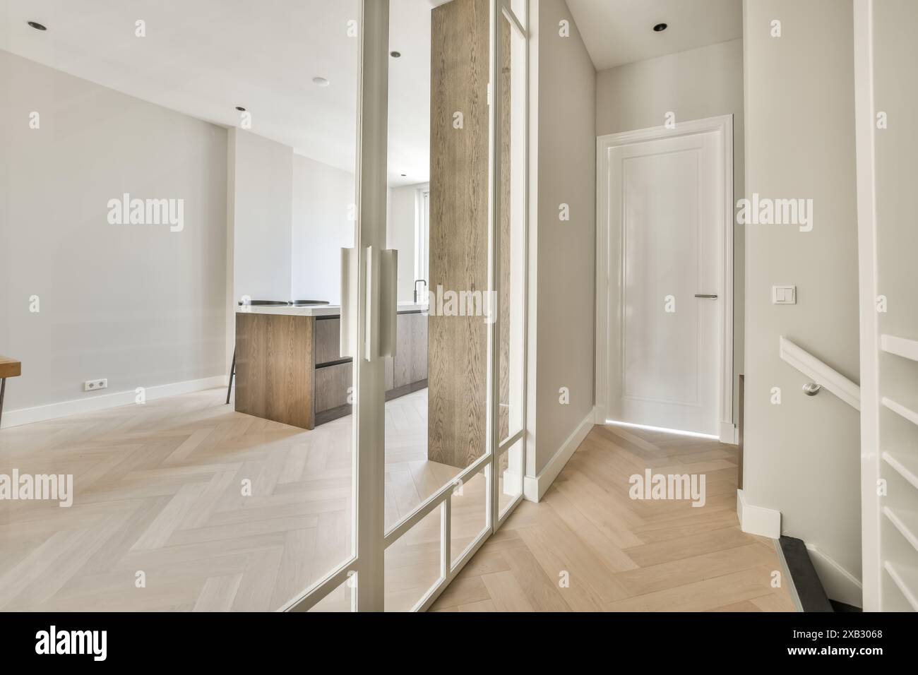 Spacious minimalist open-plan interior featuring herringbone parquet ...