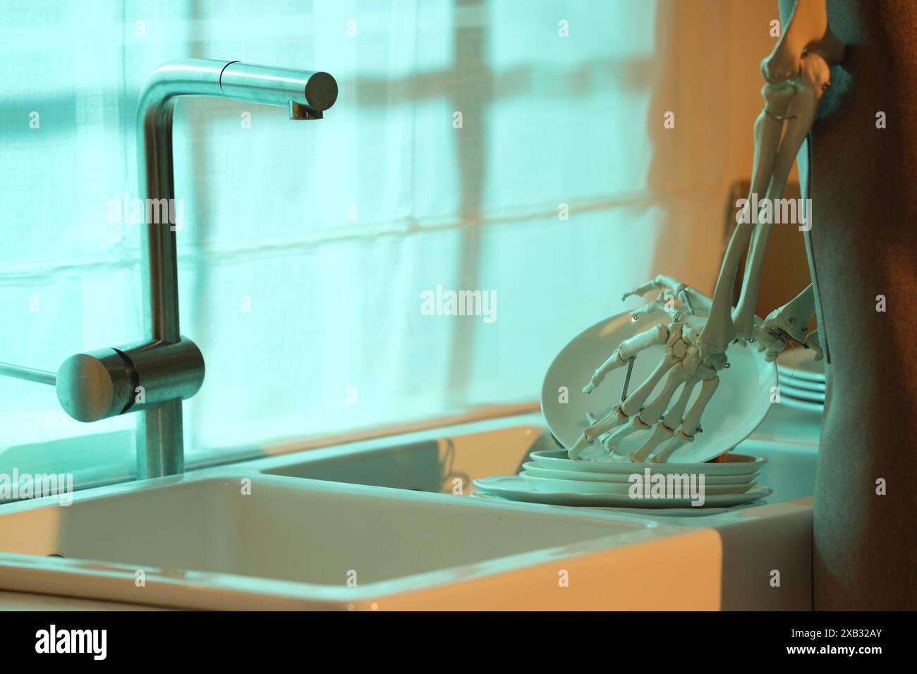 Human skeleton washing dishes in kitchen sink at night, closeup Stock ...