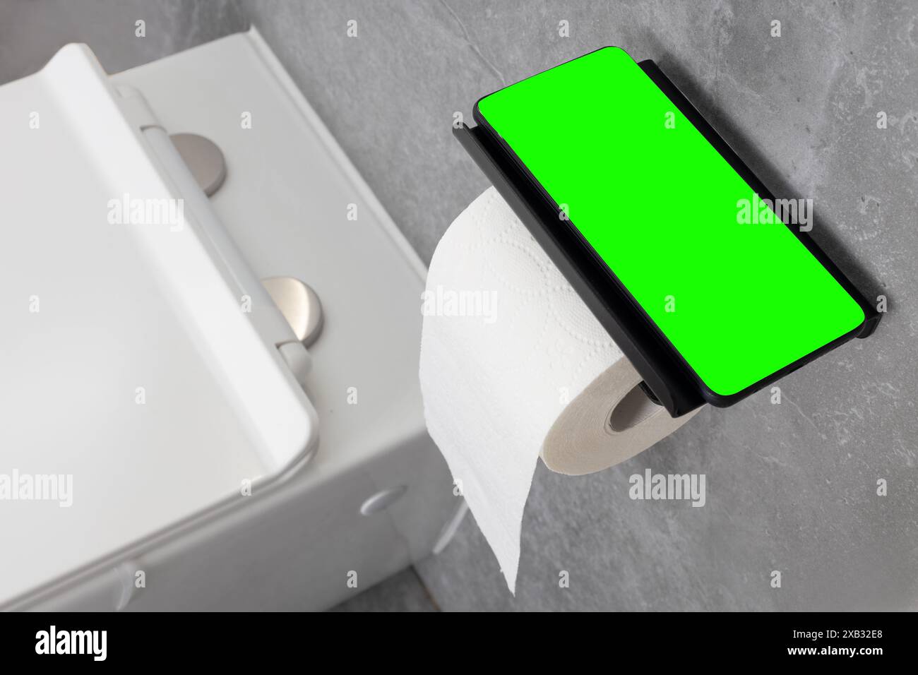 Smartphone on Toilet Paper Holder Stock Photo - Alamy