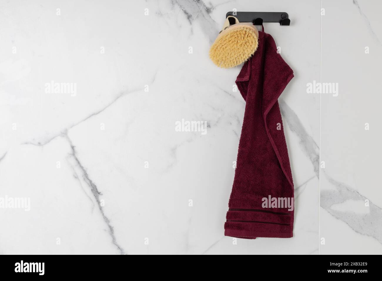 Towel and Brush Hanging on Rack Stock Photo - Alamy