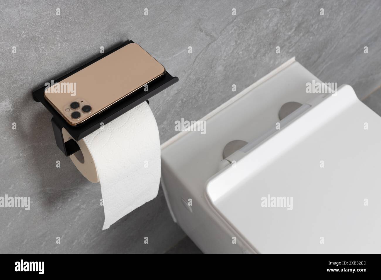 Smartphone on Toilet Paper Holder Stock Photo - Alamy