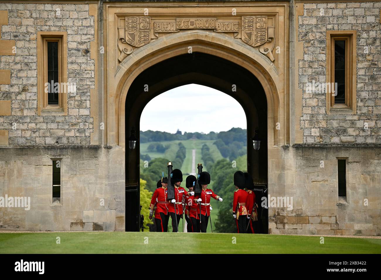 Soldiers of the Irish Guards carry the new colours covered with a black ...