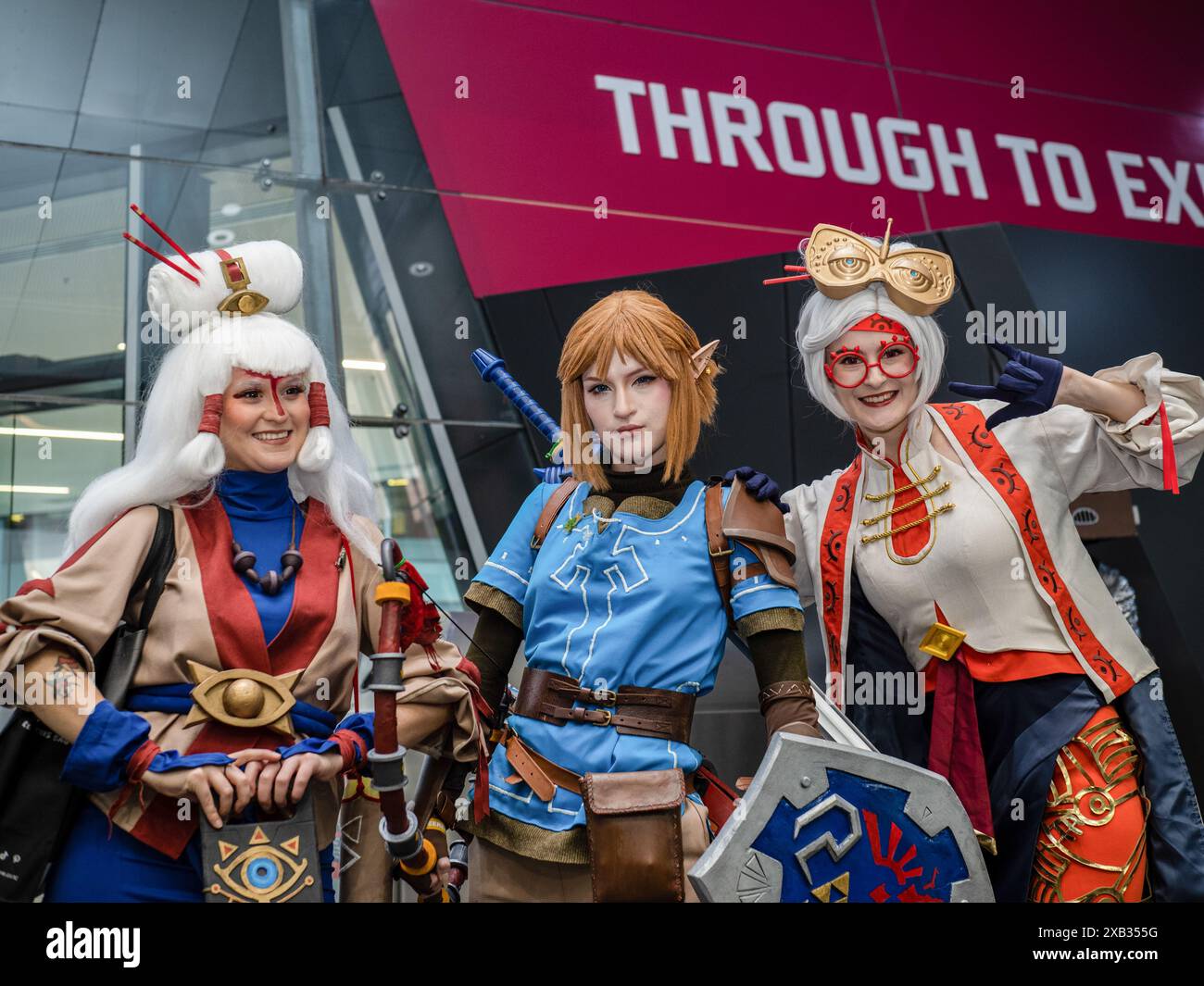 Attendees pose for photos in costumes during an event. An estimated ...