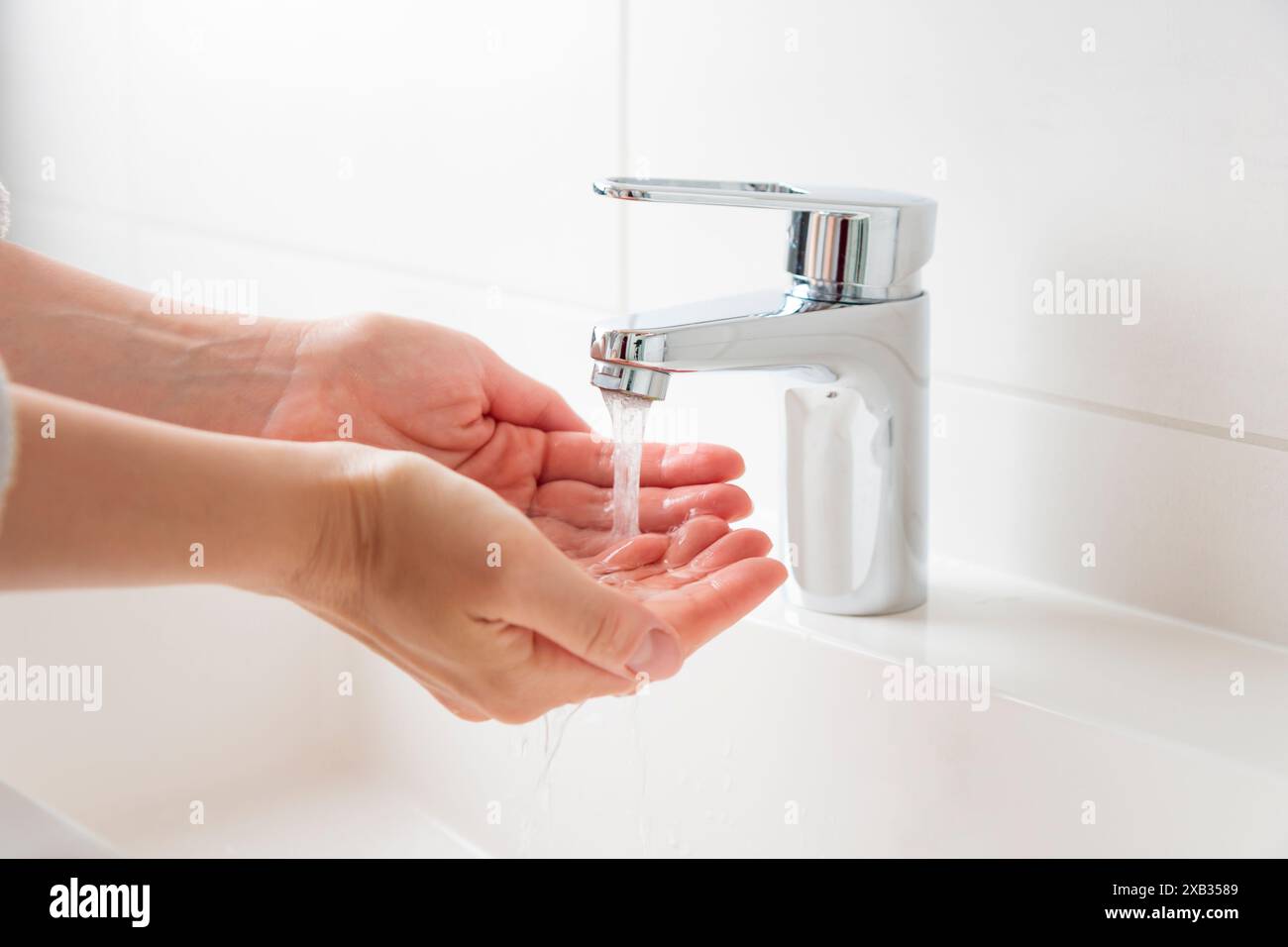 Sustainable use of natural resources. Woman is using water through flow ...
