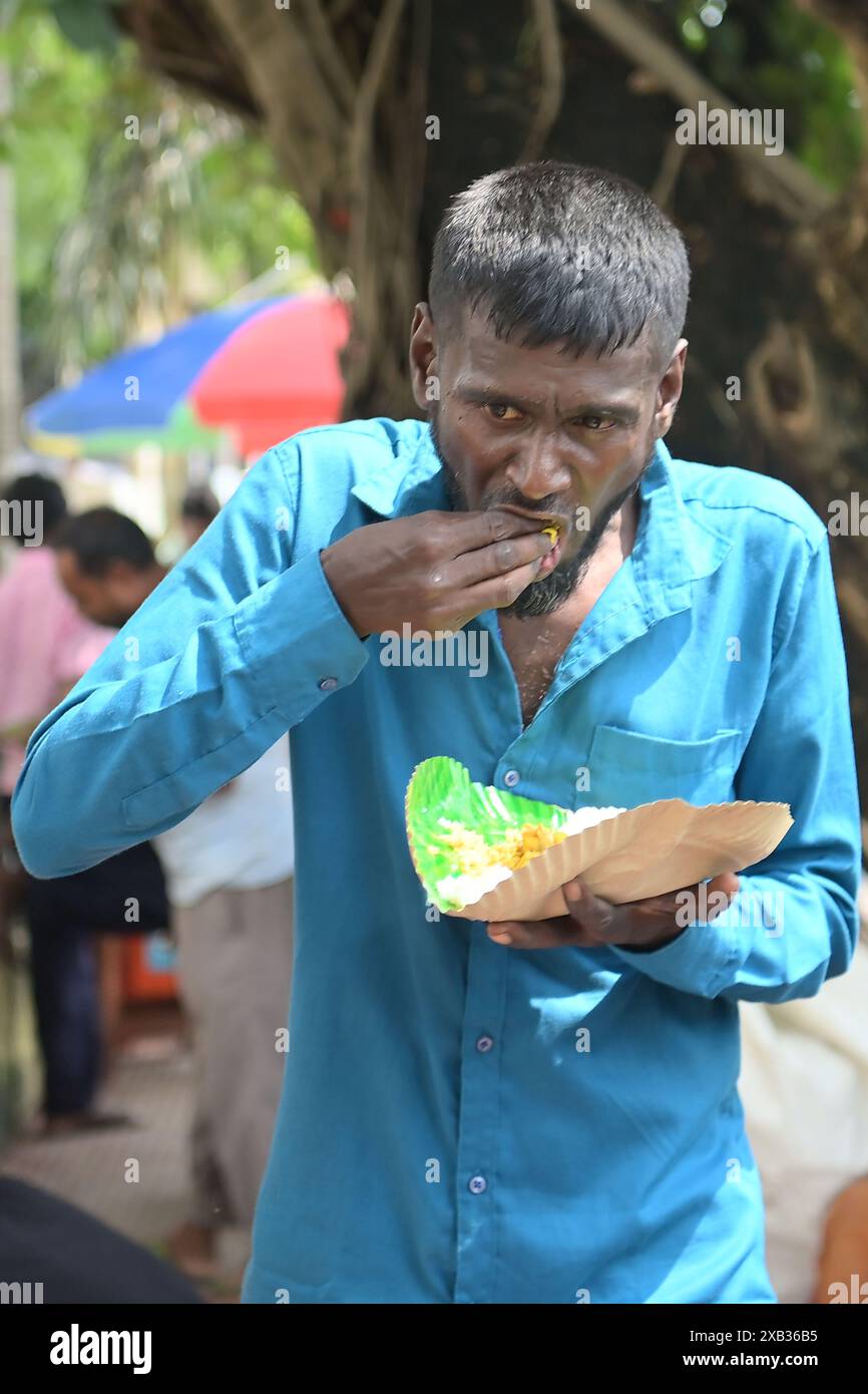 People eating food distributed by a social worker on World Food Safety ...