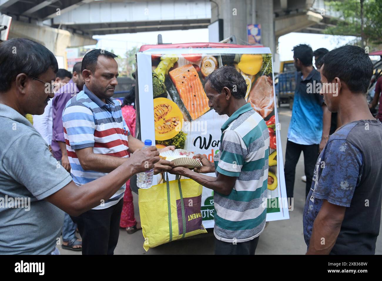 People get food from a social worker on World Food Safety Day ...