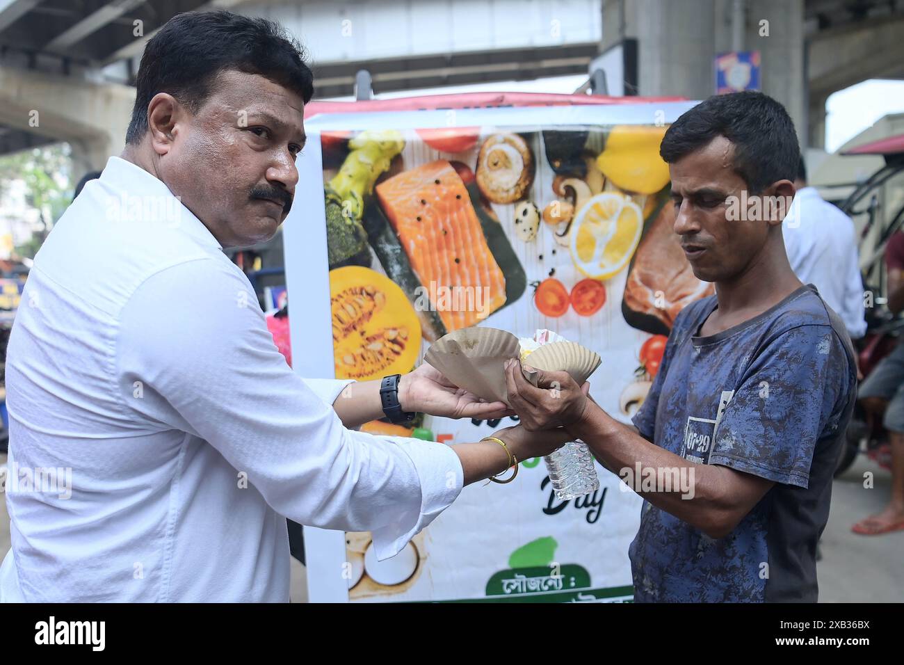 People get food from a social worker on World Food Safety Day ...