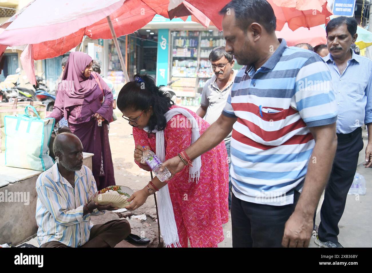 People get food from a social worker on World Food Safety Day ...