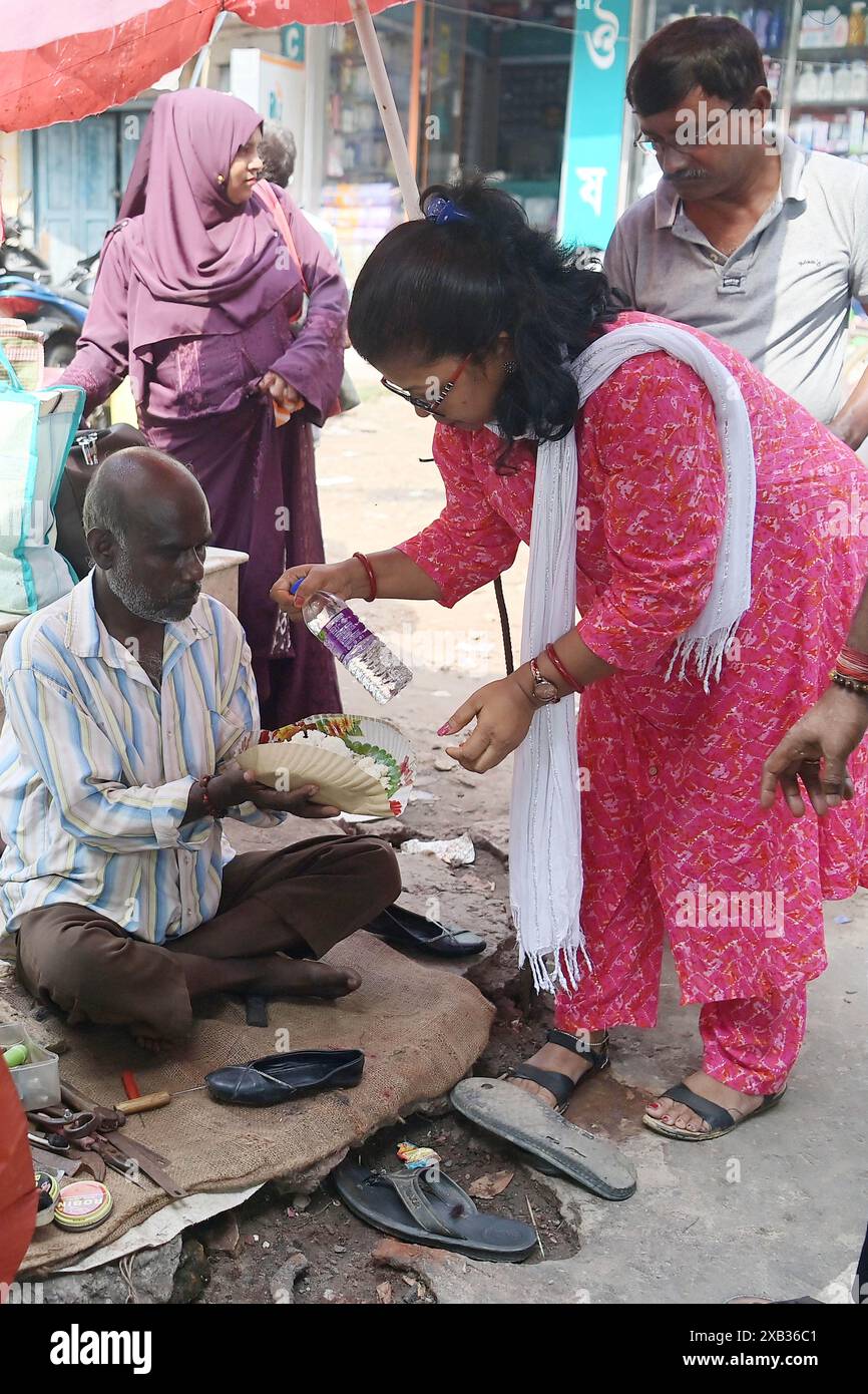 People get food from a social worker on World Food Safety Day ...