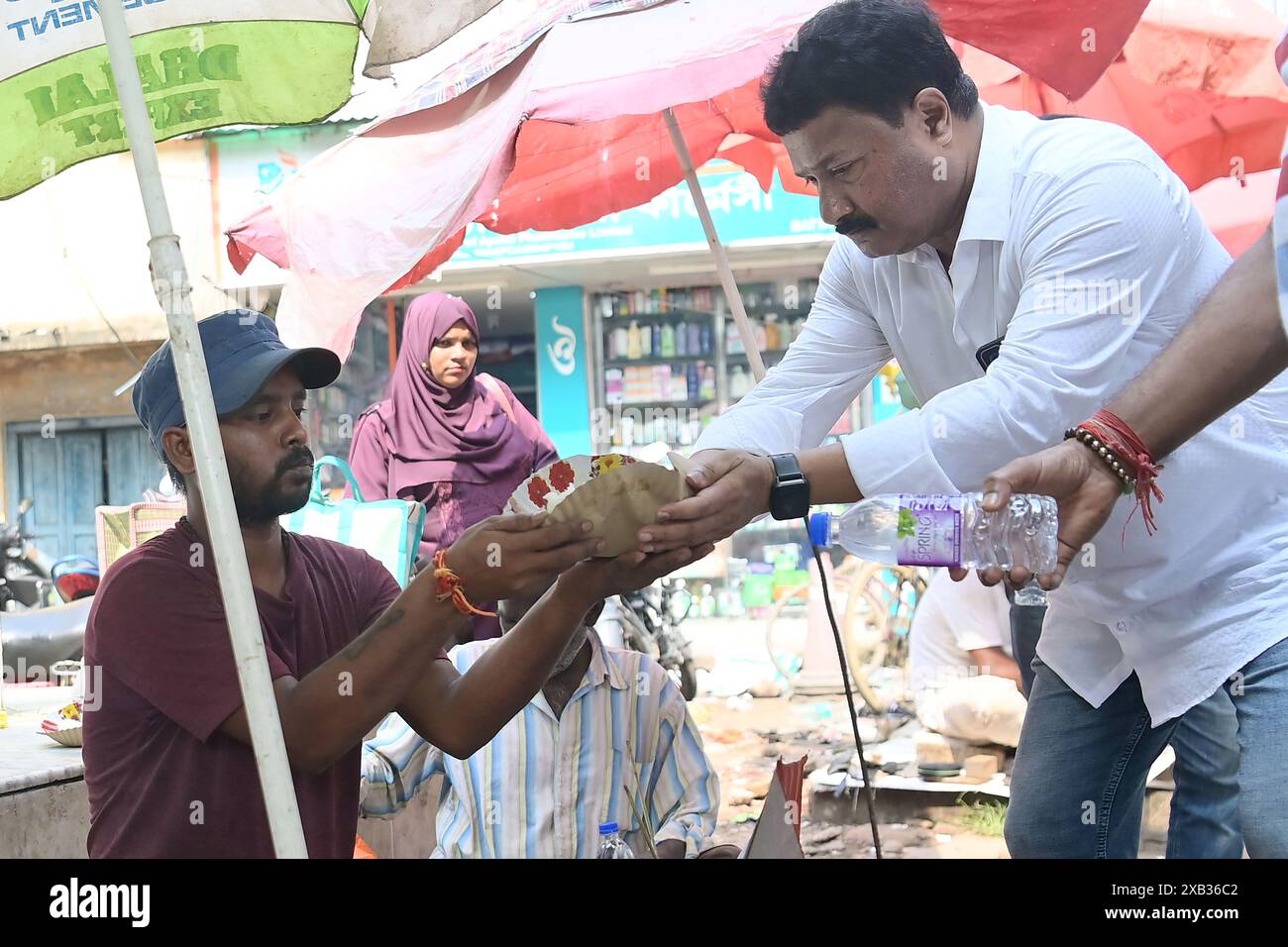 People get food from a social worker on World Food Safety Day ...