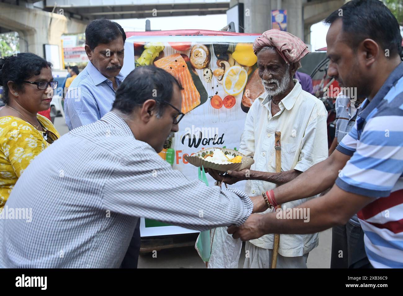 People get food from a social worker on World Food Safety Day ...