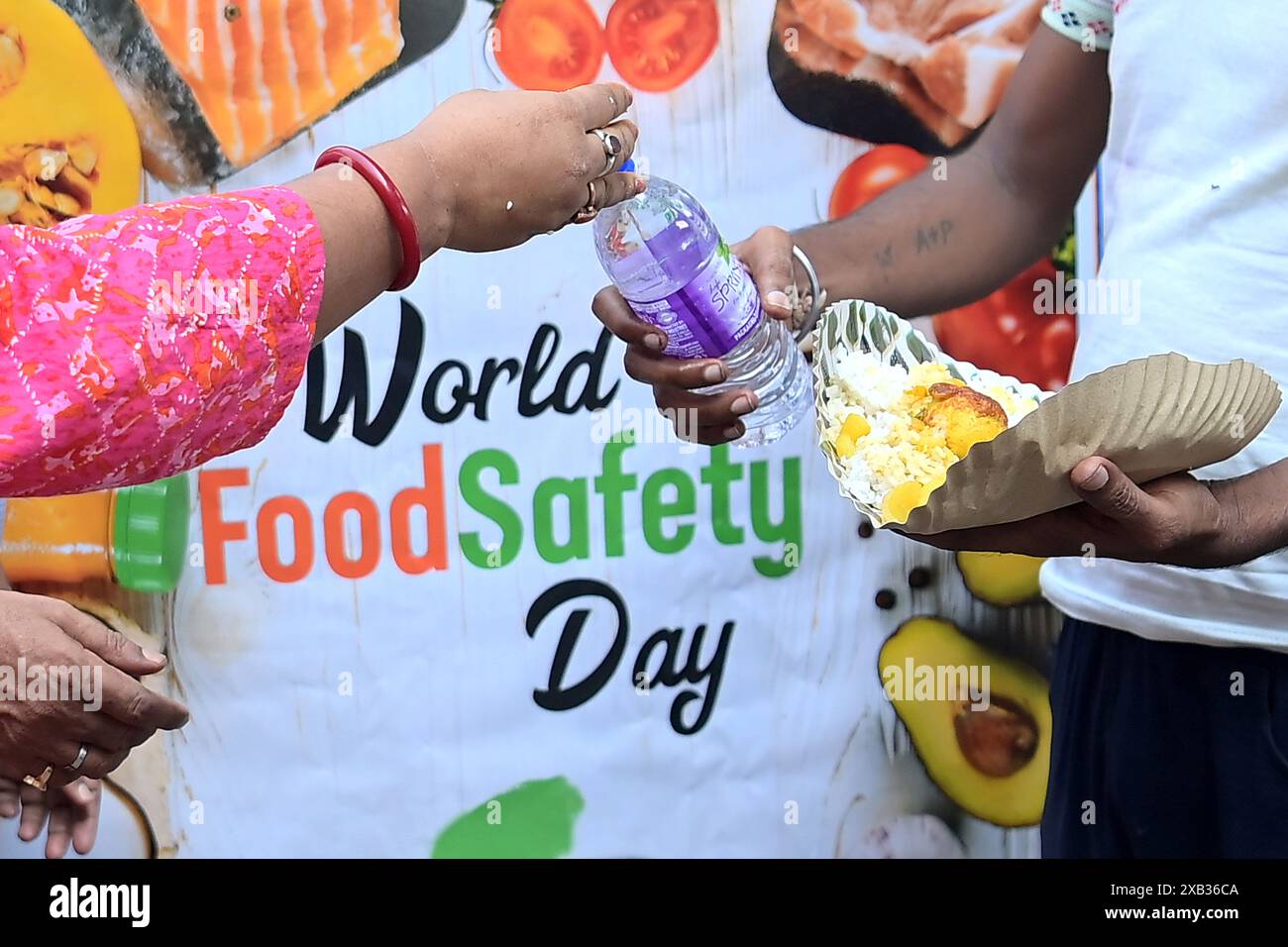 People get food from a social worker on World Food Safety Day ...