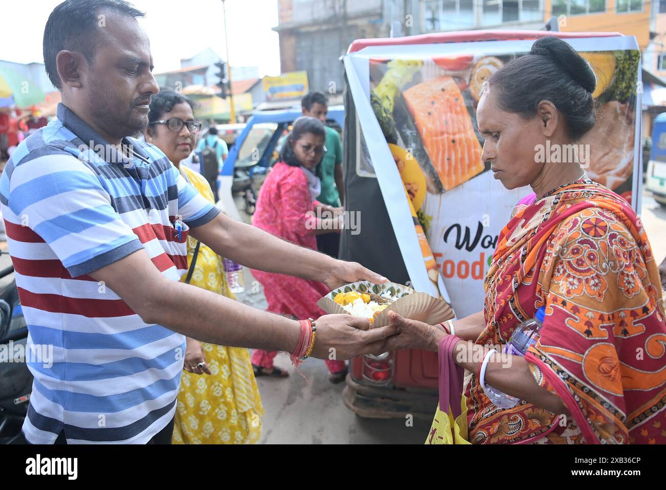 People get food from a social worker on World Food Safety Day ...
