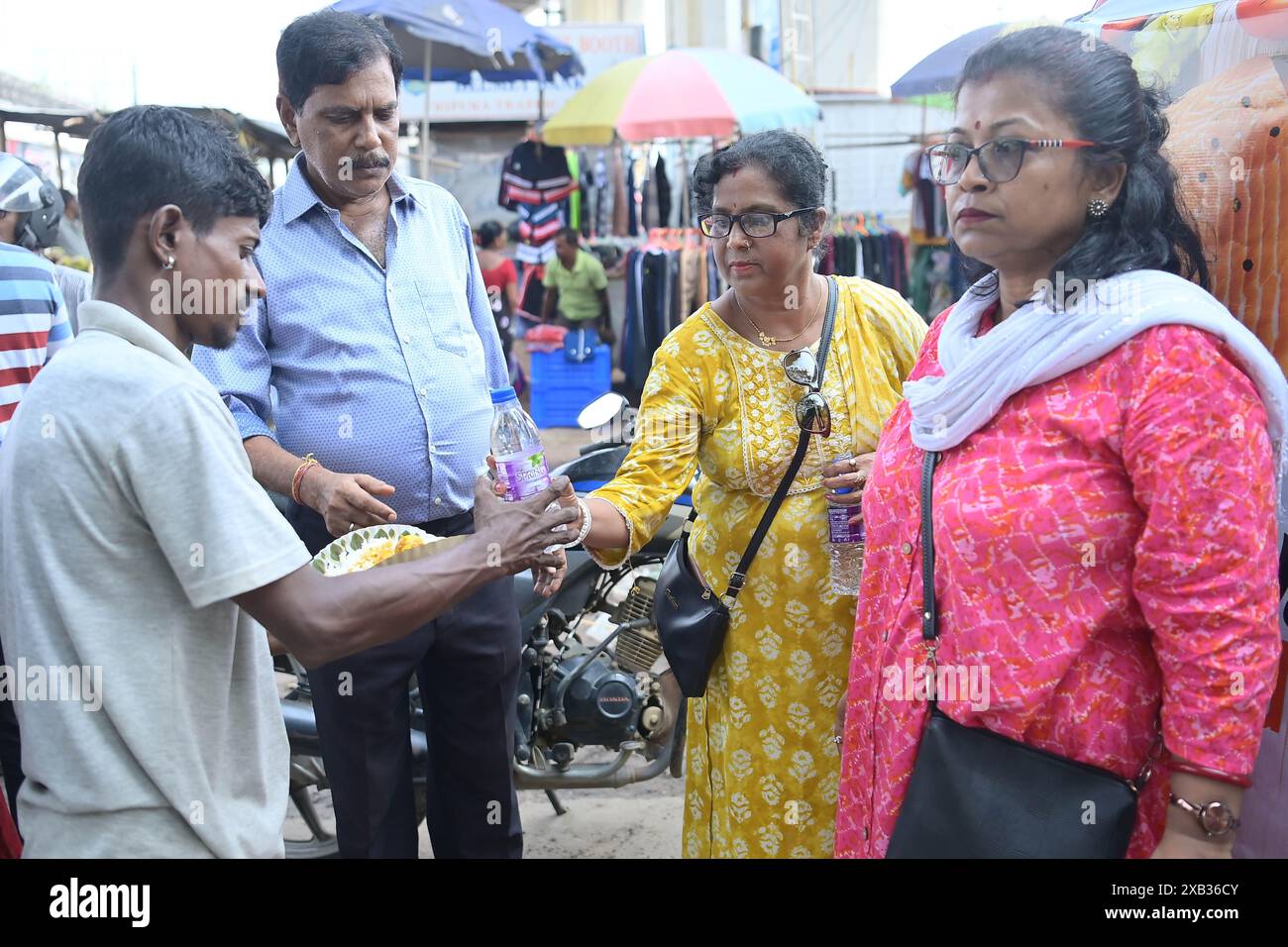 People get food from a social worker on World Food Safety Day ...