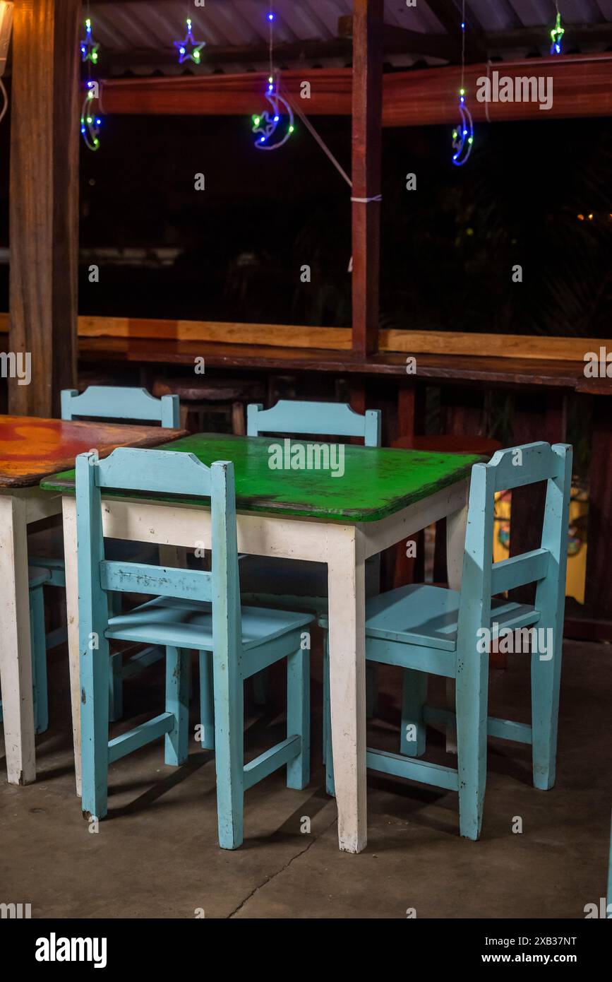 Quaint restaurant with rustic tables and chairs, El Tunco, surf town in ...