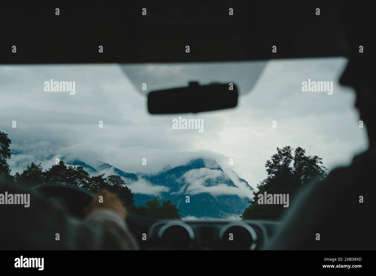 Mountain range seen through windshield of car Stock Photo - Alamy