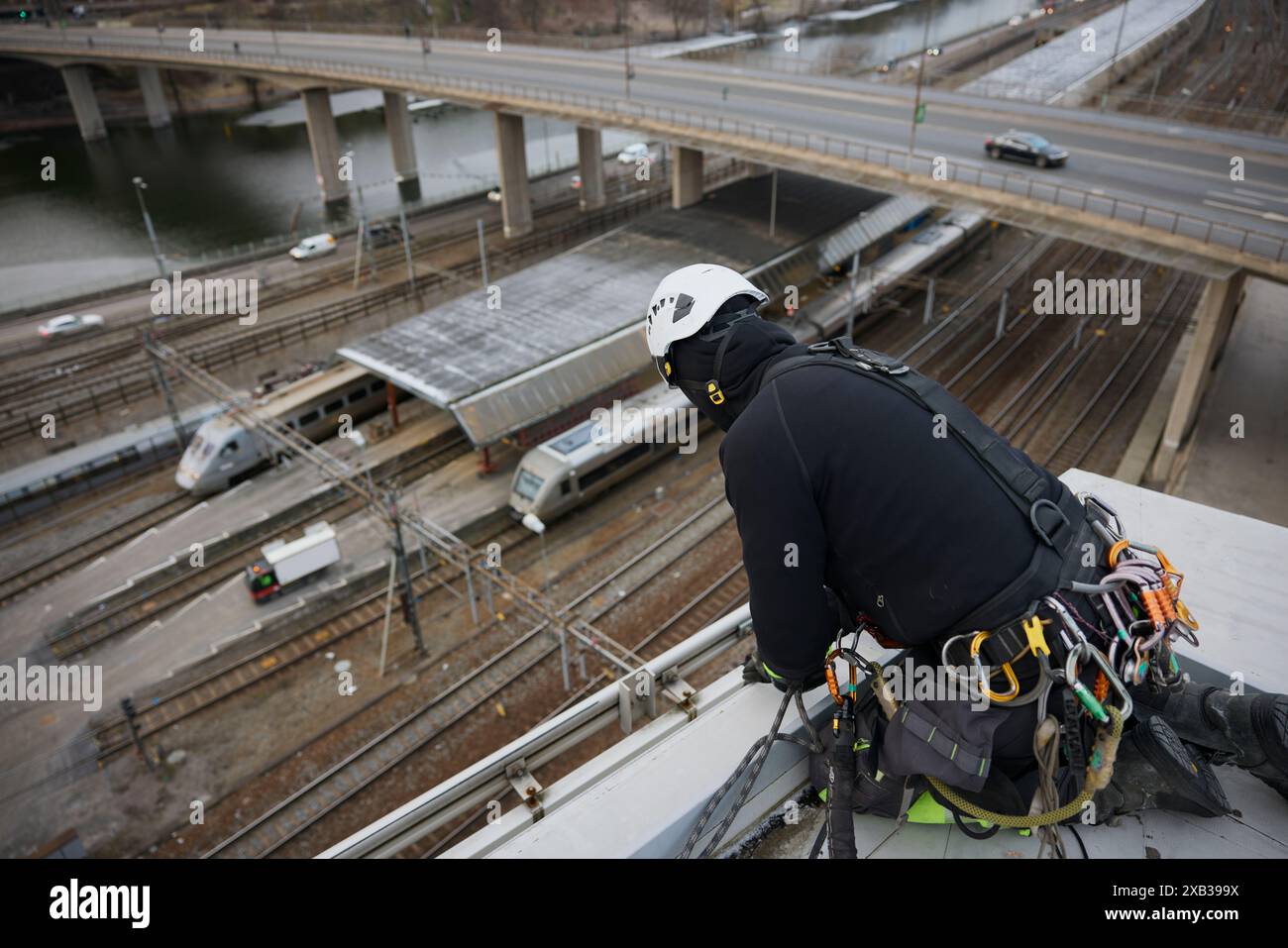 High angle view of male rope access worker working on rooftop Stock ...