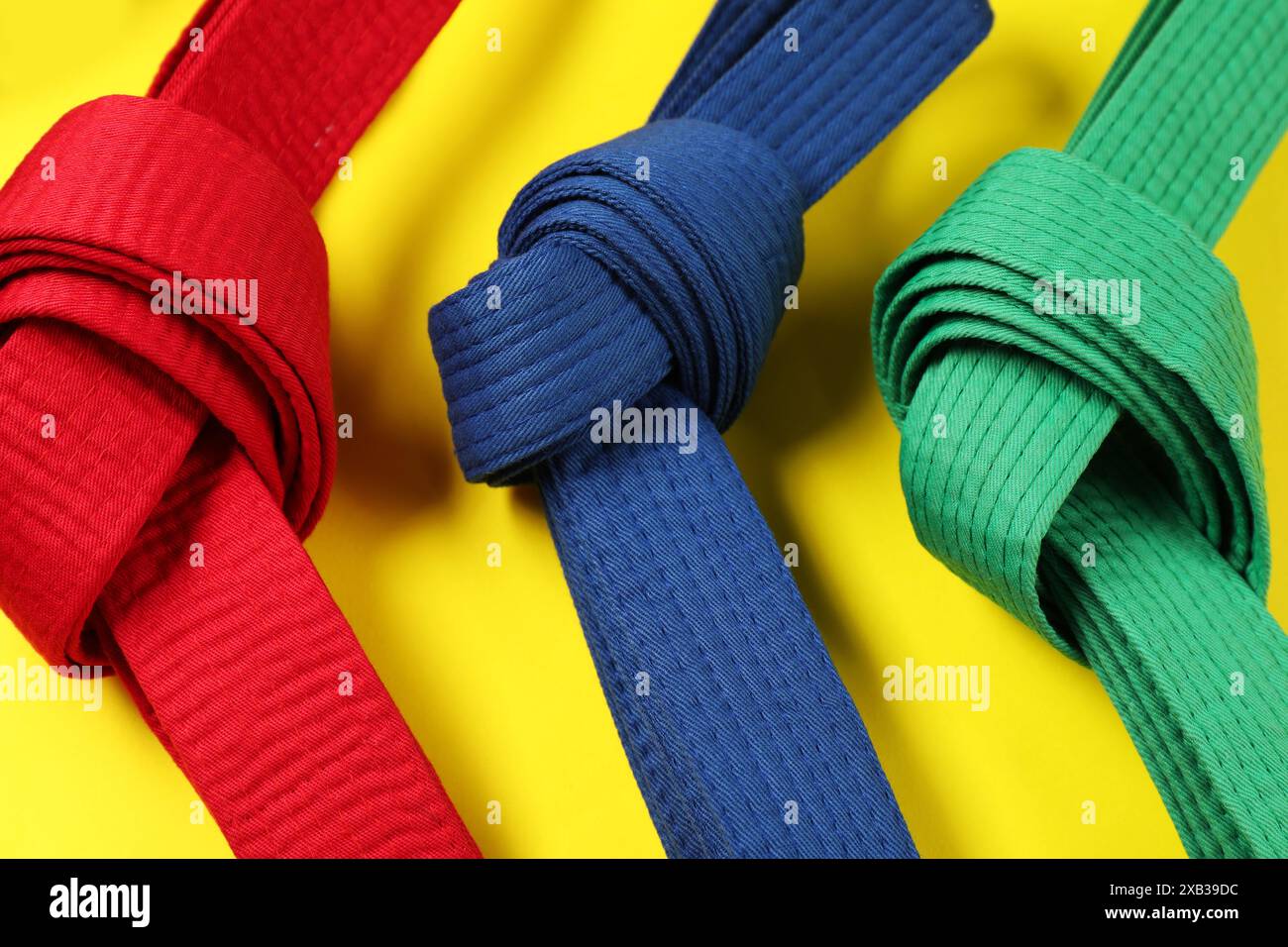 Colorful karate belts on yellow background, closeup Stock Photo - Alamy