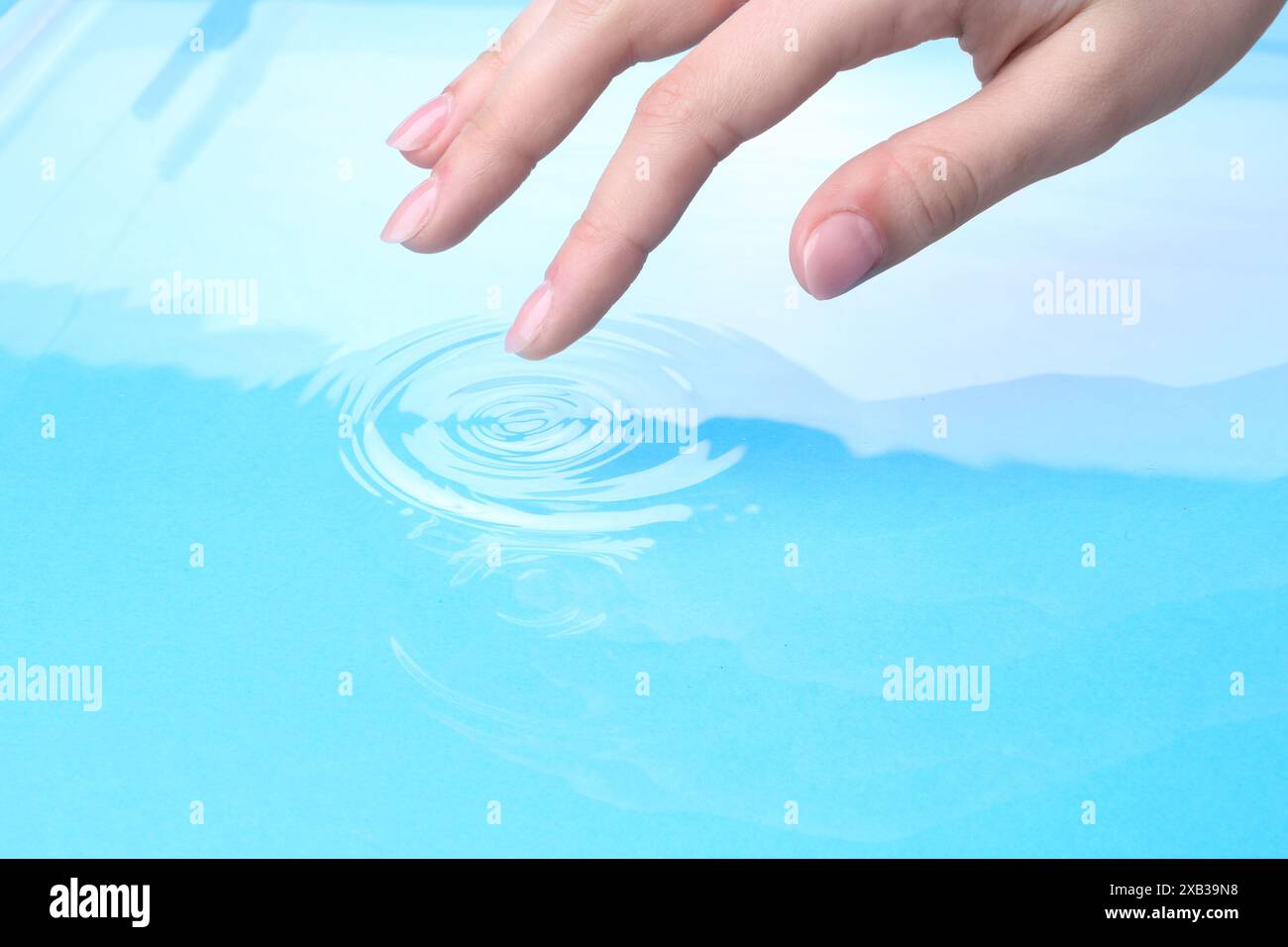 Woman touching clear water, closeup. Making ripples Stock Photo - Alamy