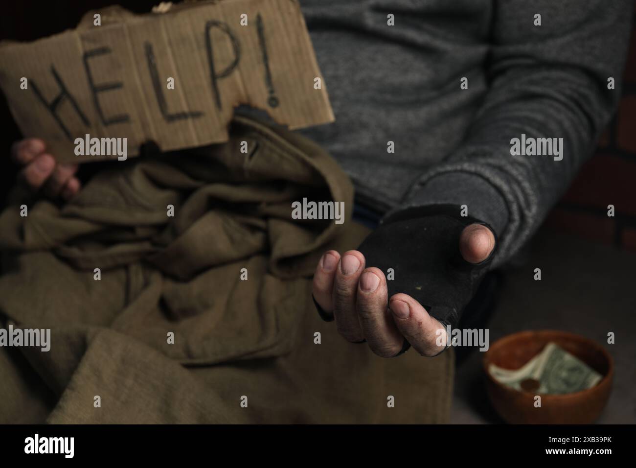 Poor homeless man with help sign begging for money, closeup. Charity ...