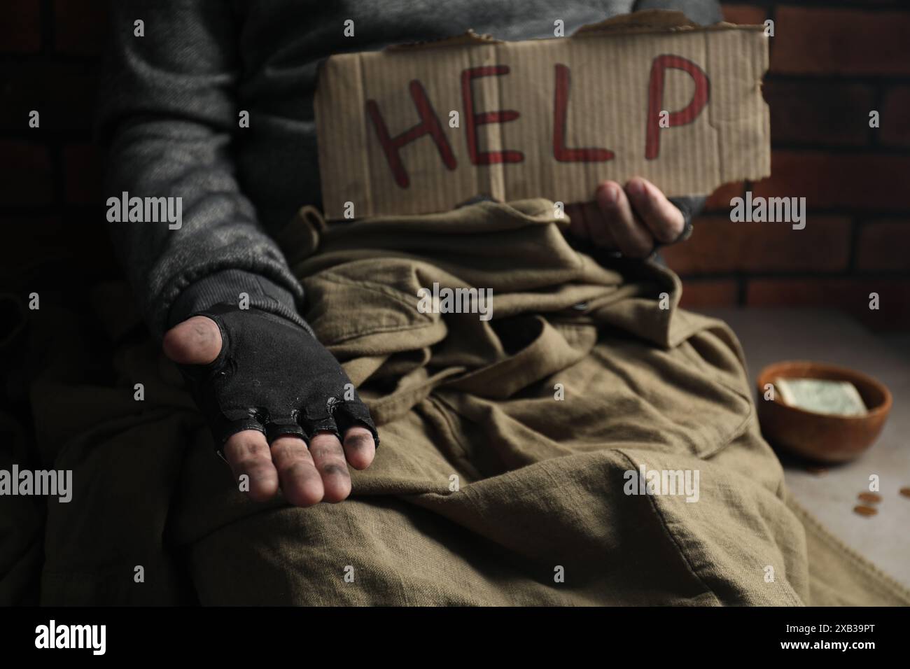 Poor homeless man with help sign begging for money, closeup. Charity ...