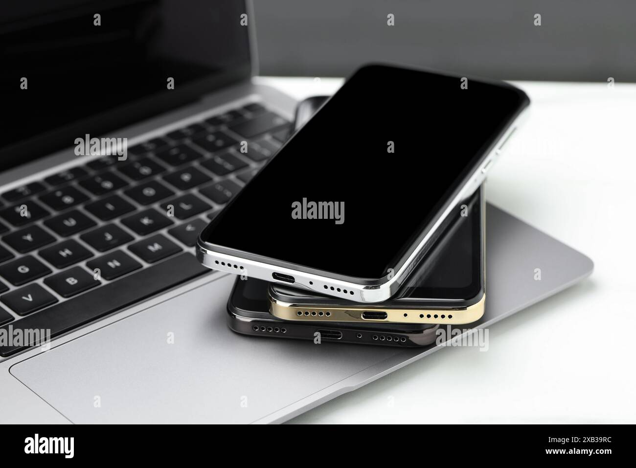 Stack of electronic devices on white table Stock Photo - Alamy