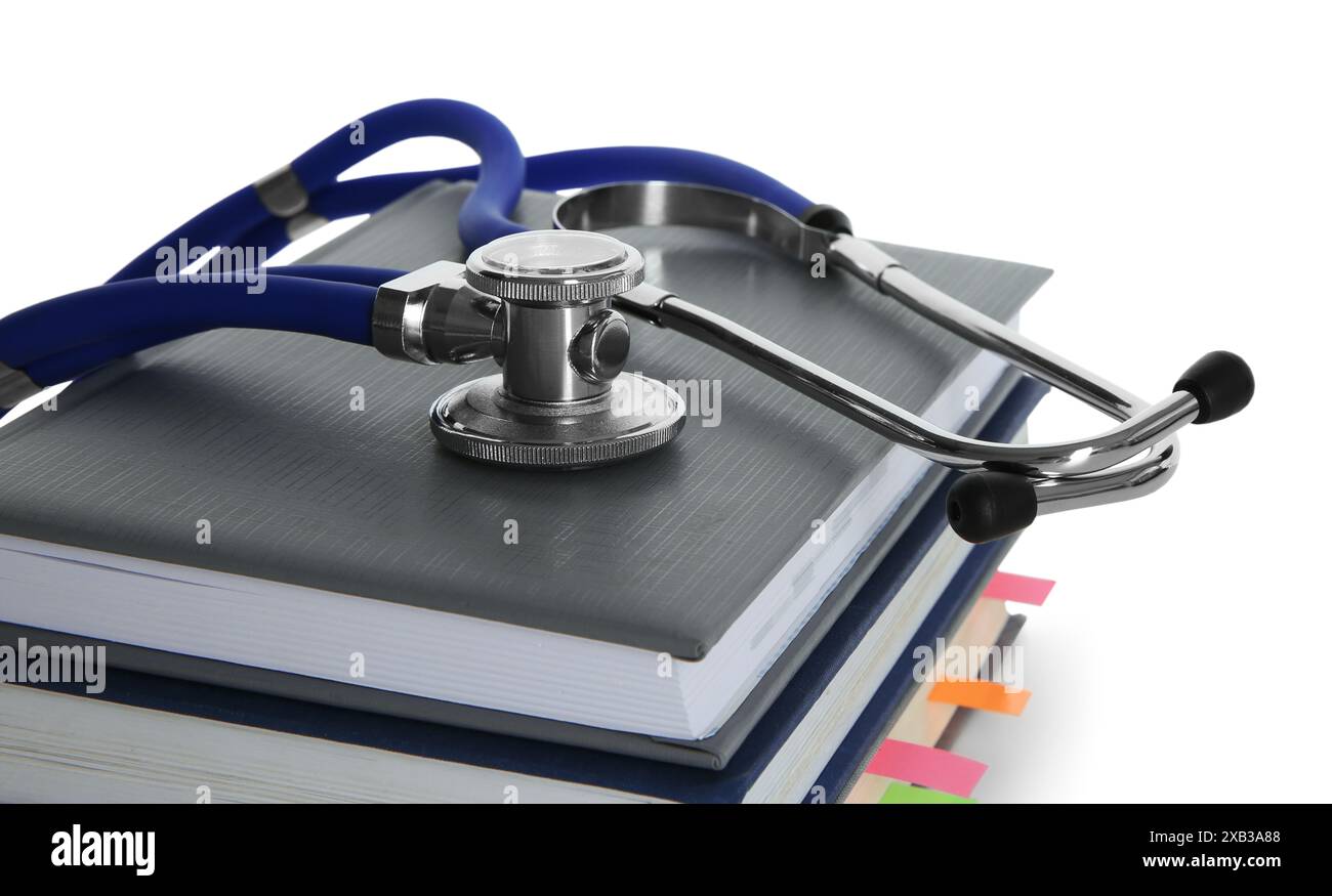 Stethoscope on stack of books against white background Stock Photo - Alamy