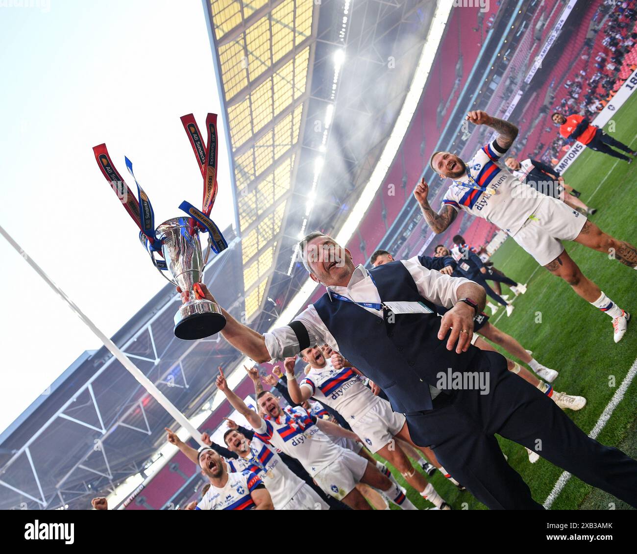 London, England - 8th June 2024 -Darryl Powell Head Coach of Wakefield Trinity lifts the Trophy ...