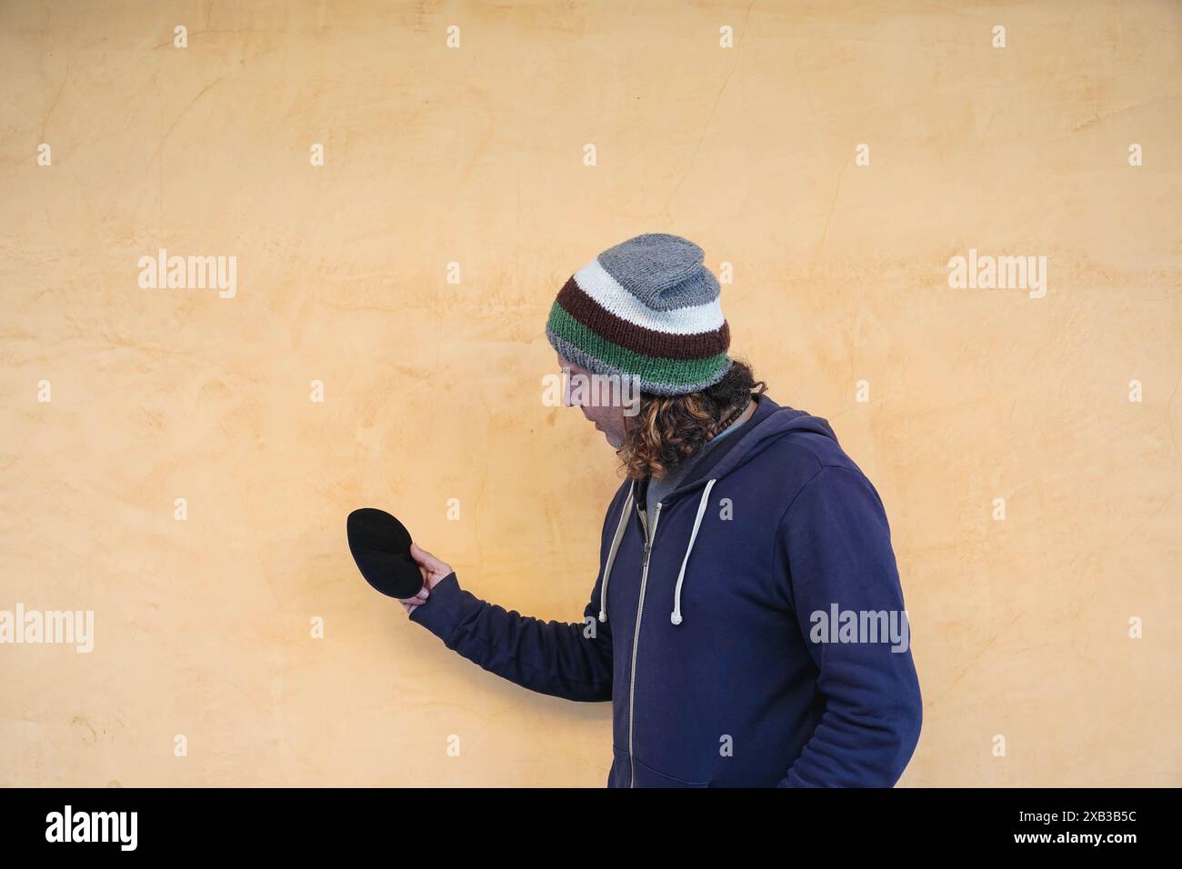 A man looking at an ostomy bag for a colon cancer stoma. Oncology day ...