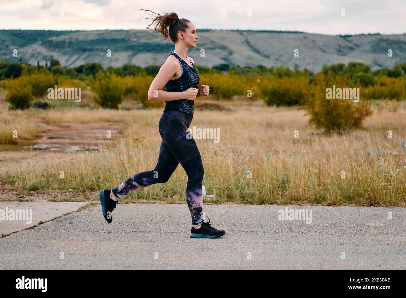 Determined Athlete Running in the Sun amidst Beautiful Nature Stock ...