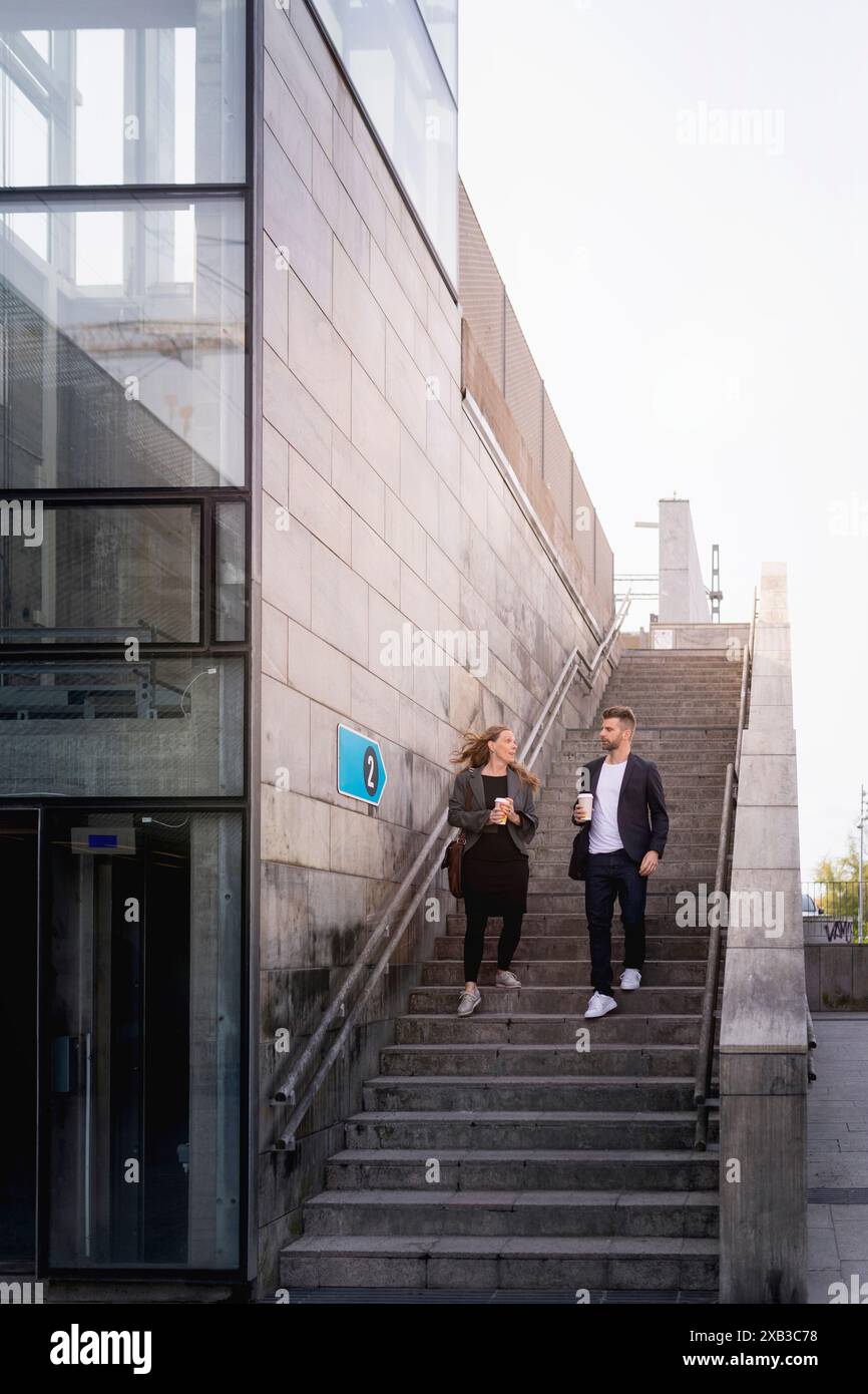 Smart man walking down steps hi-res stock photography and images - Alamy