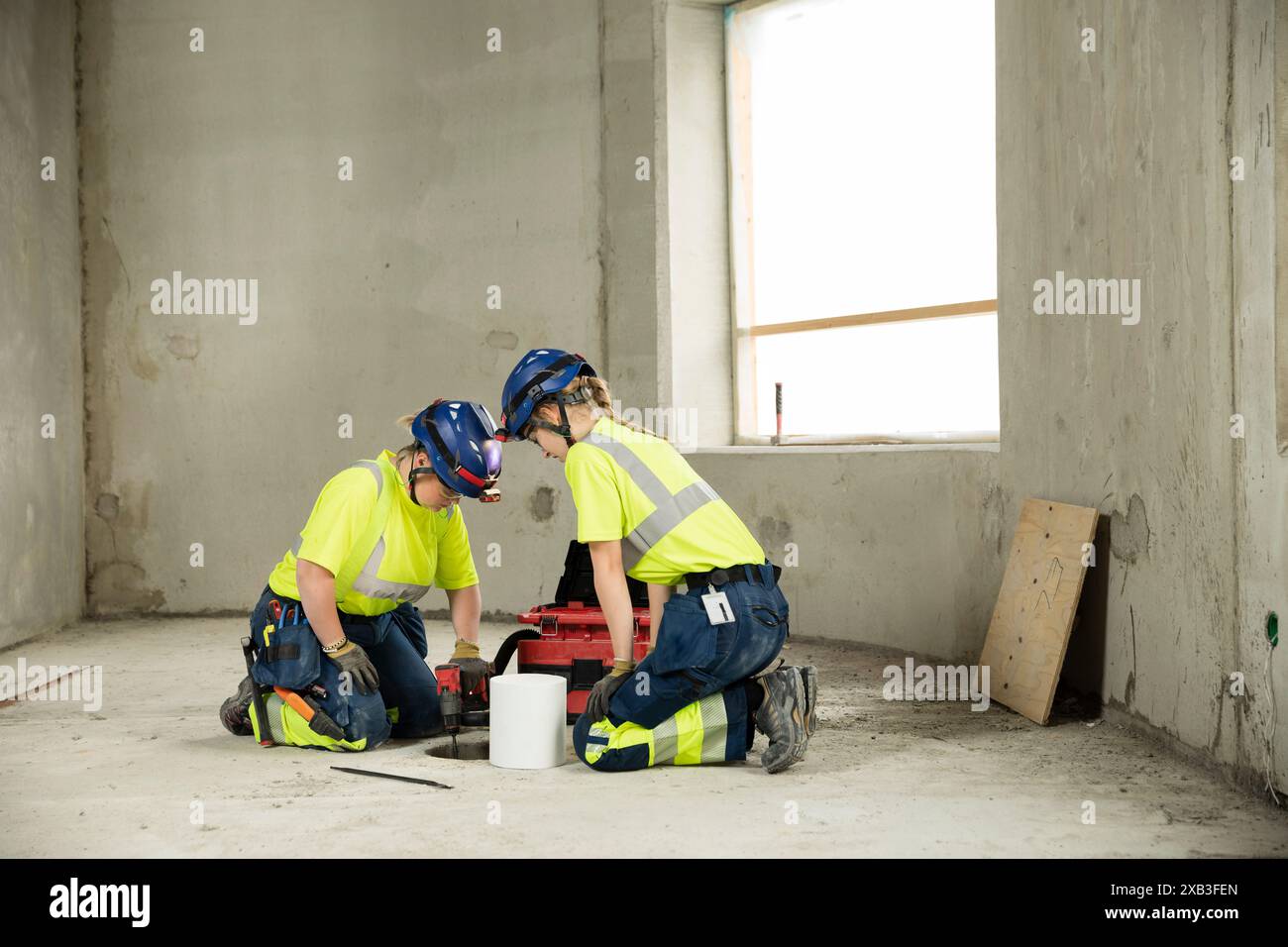 Female civil engineers in protective workwear working at construction ...