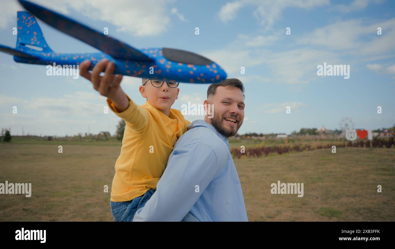 Happy family smiling Caucasian man male father dad carrying piggy back ...
