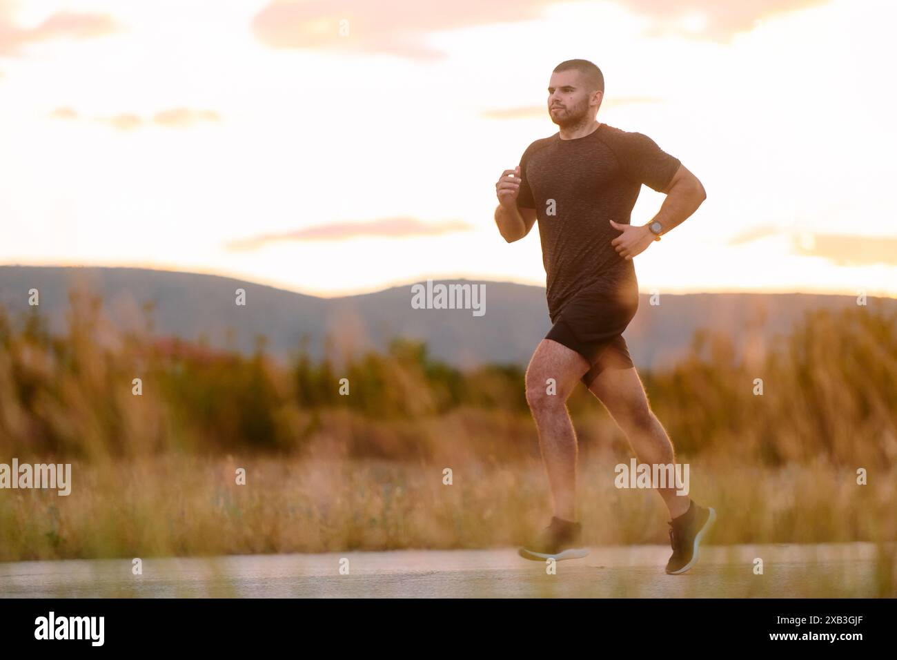 Athletic Man Jogging in the Sun, Preparing His Body for Life's Extreme ...